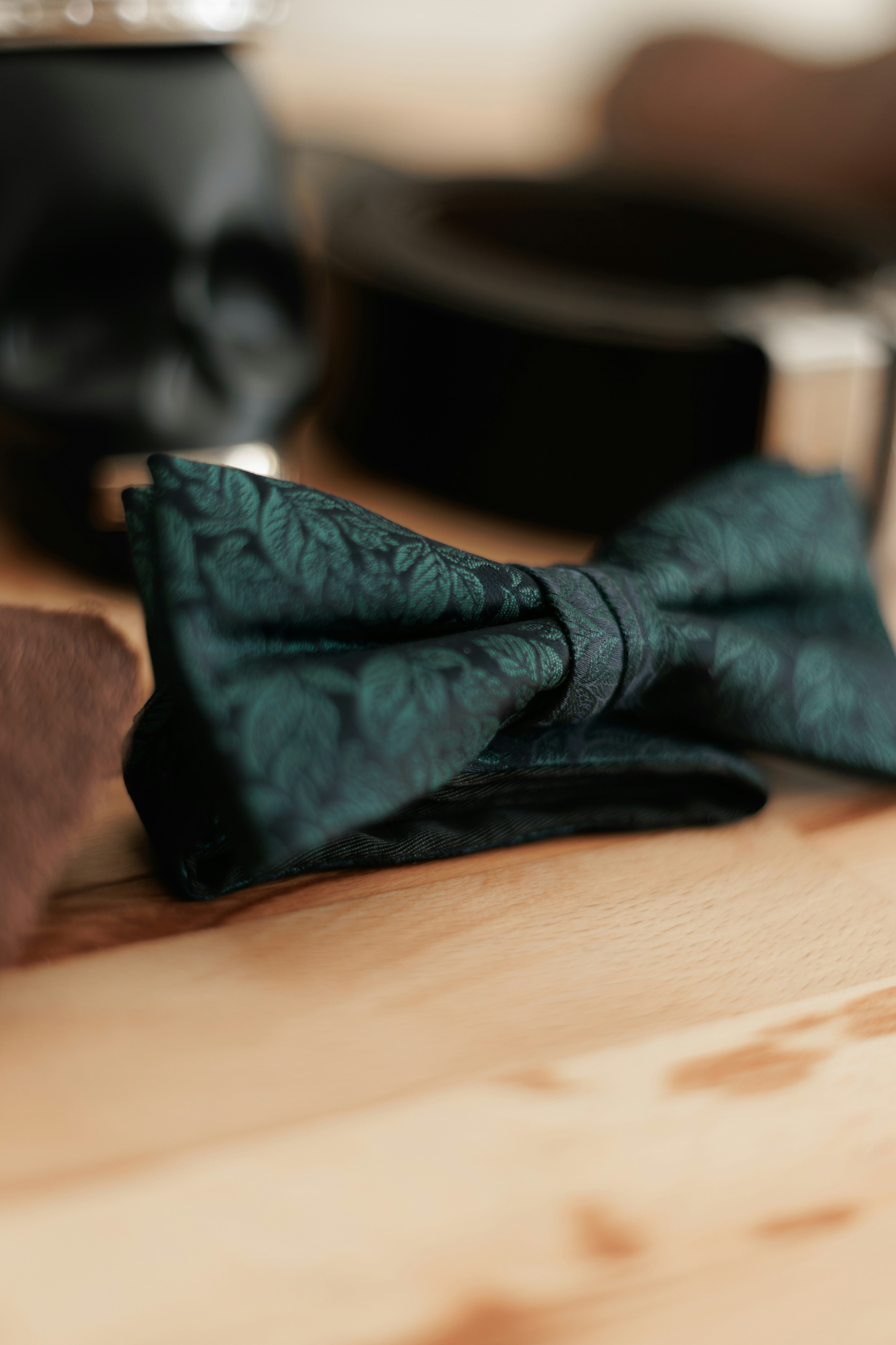 Emerald Satin Bow Tie on a Warm Wooden Stage