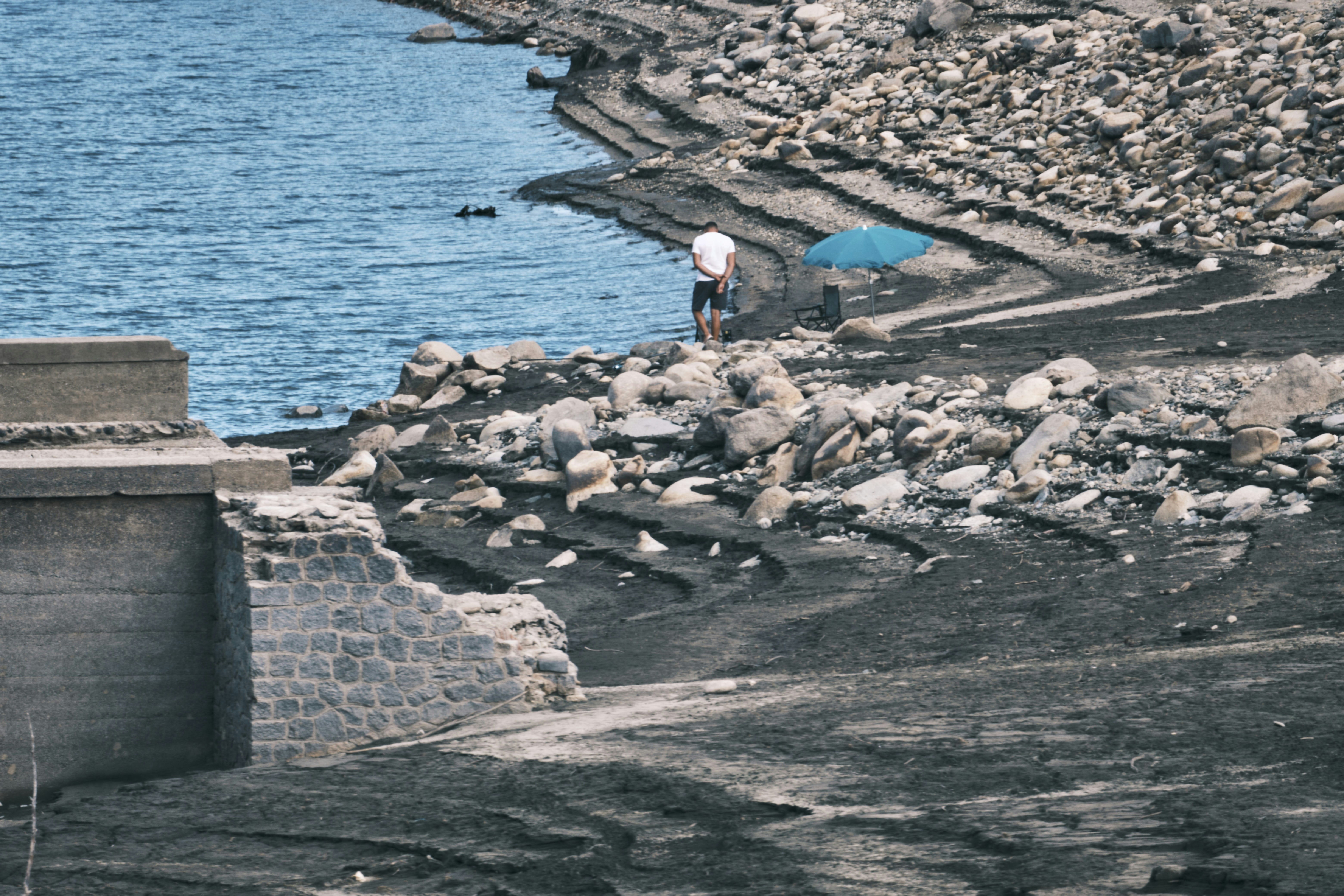 Blue Umbrella by the Sea: A Quiet Corner of the Shore