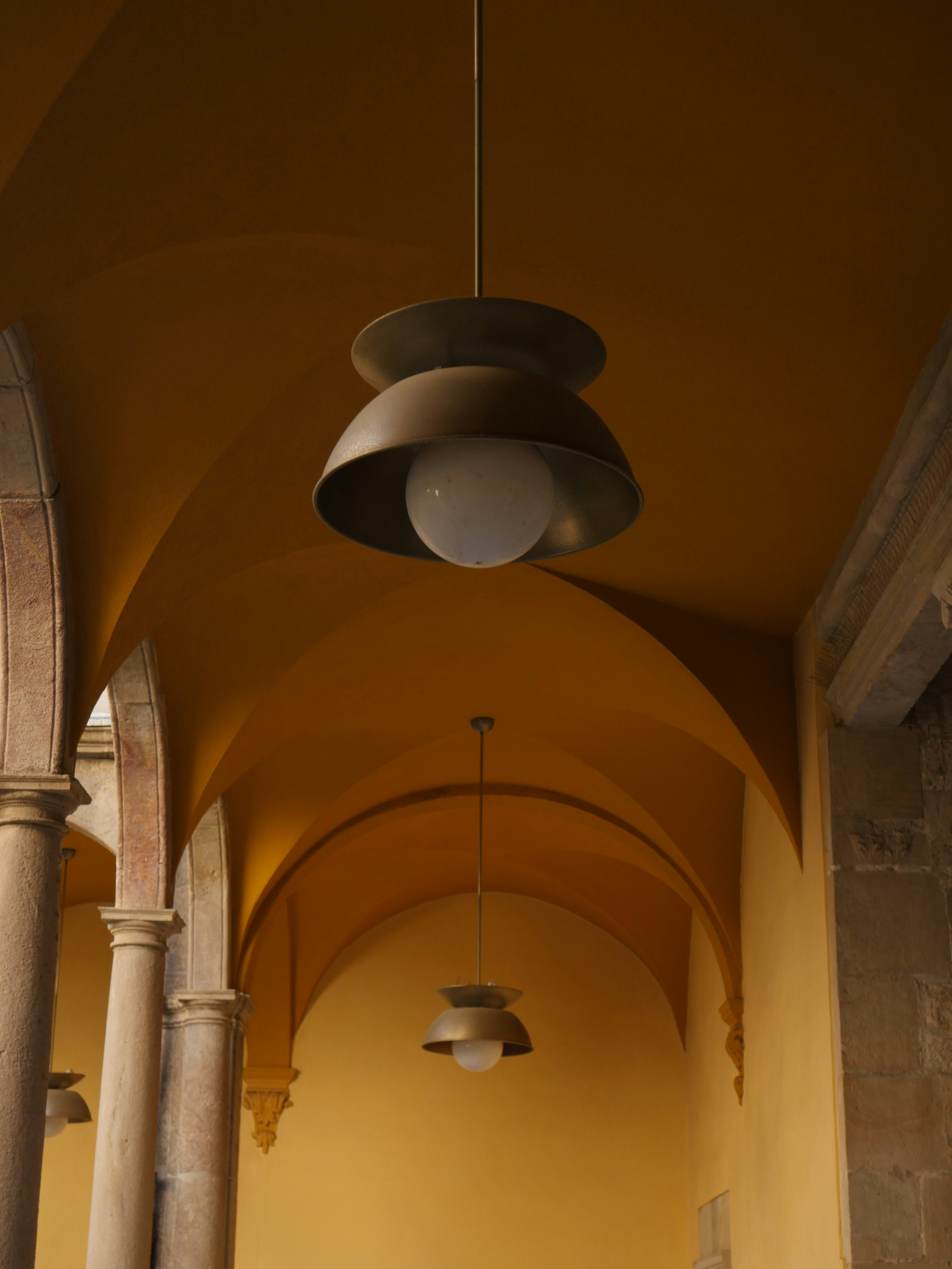 Haloed Vaults: A Corridor of Golden Arches and Floating Orbs