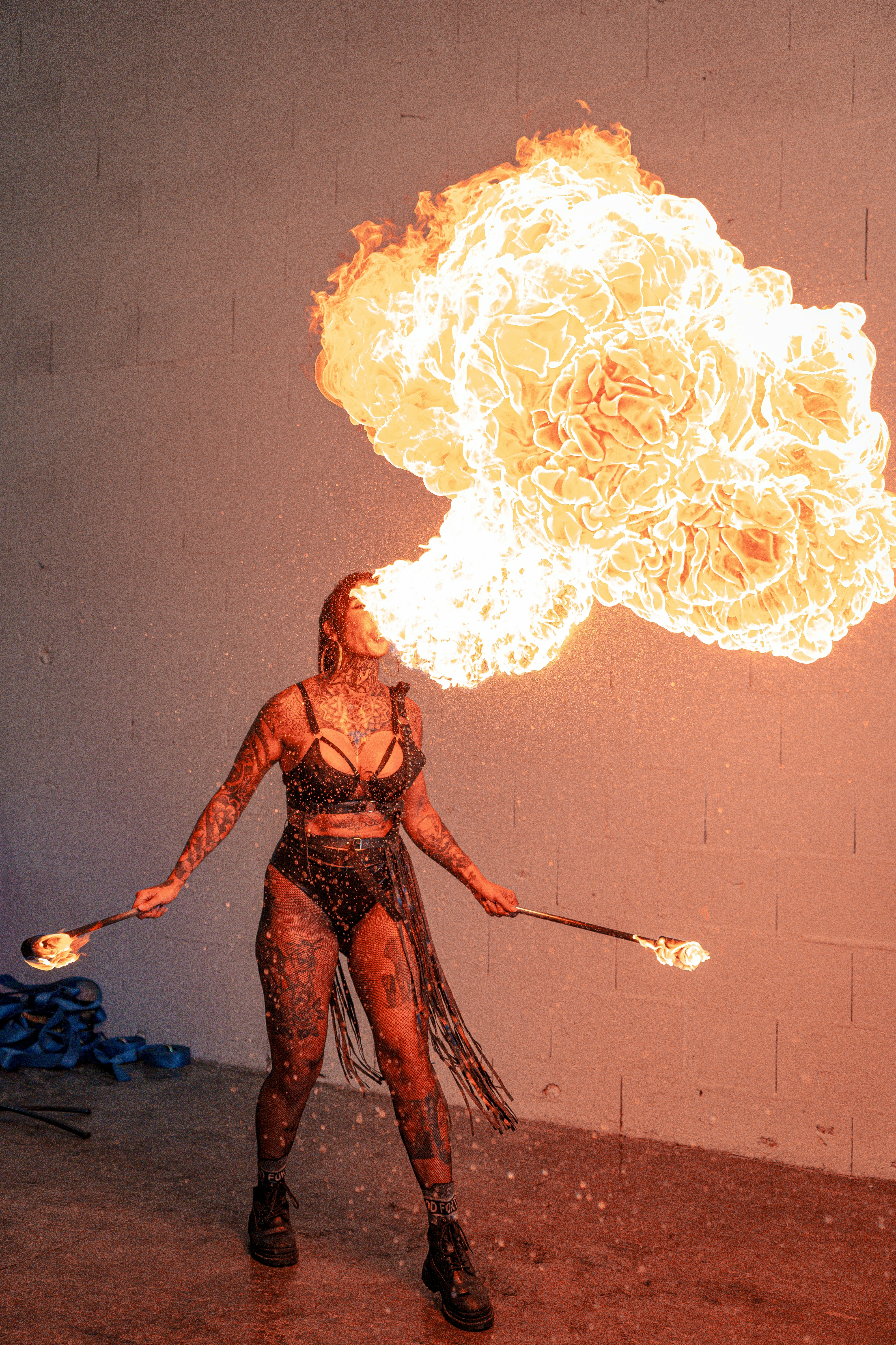 A woman in a black outfit holding a fire wand photo – Free Adult Image ...