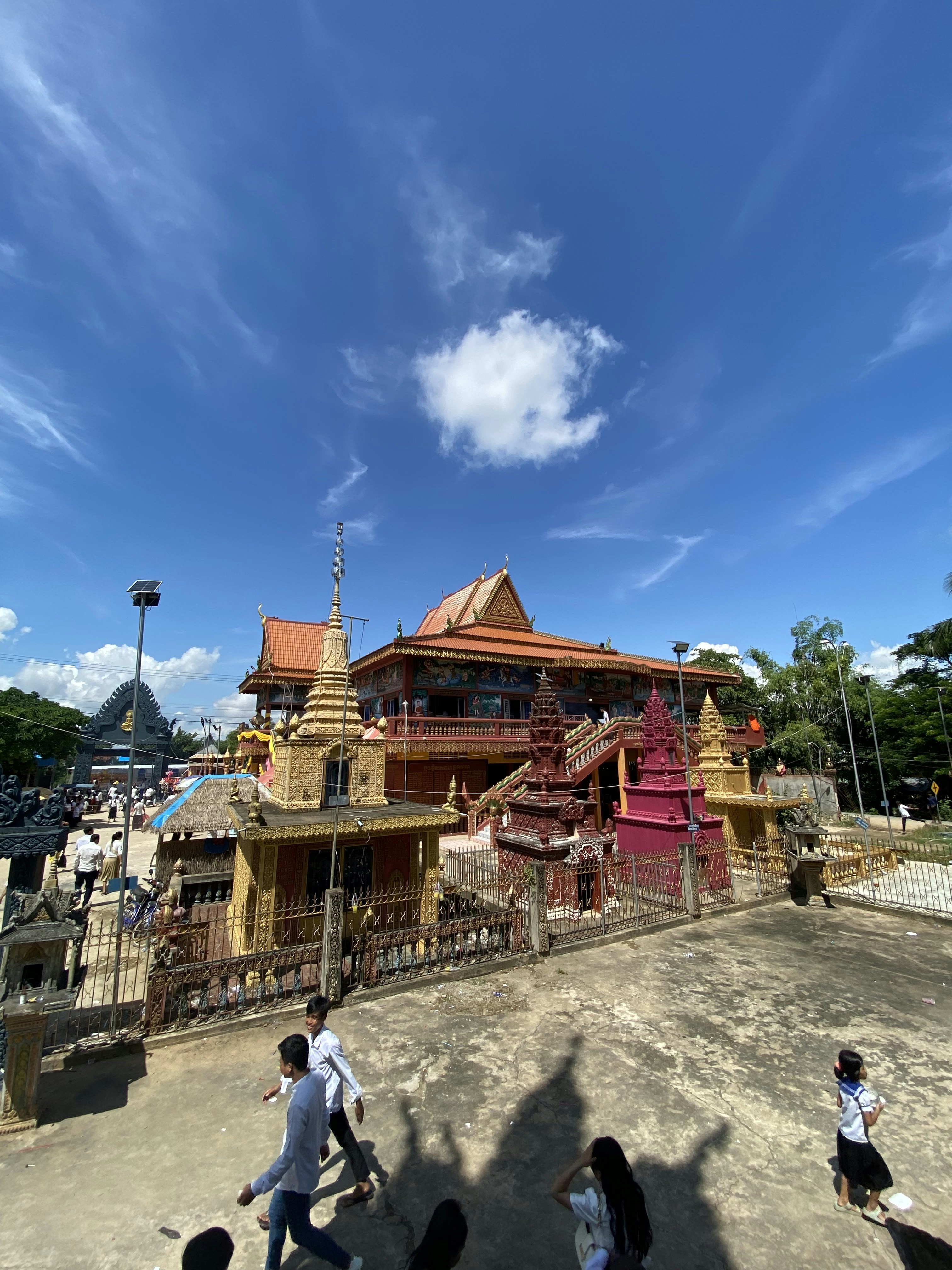 Gold Spires and Crimson Roofs Rise Above a Sunlit Temple Complex