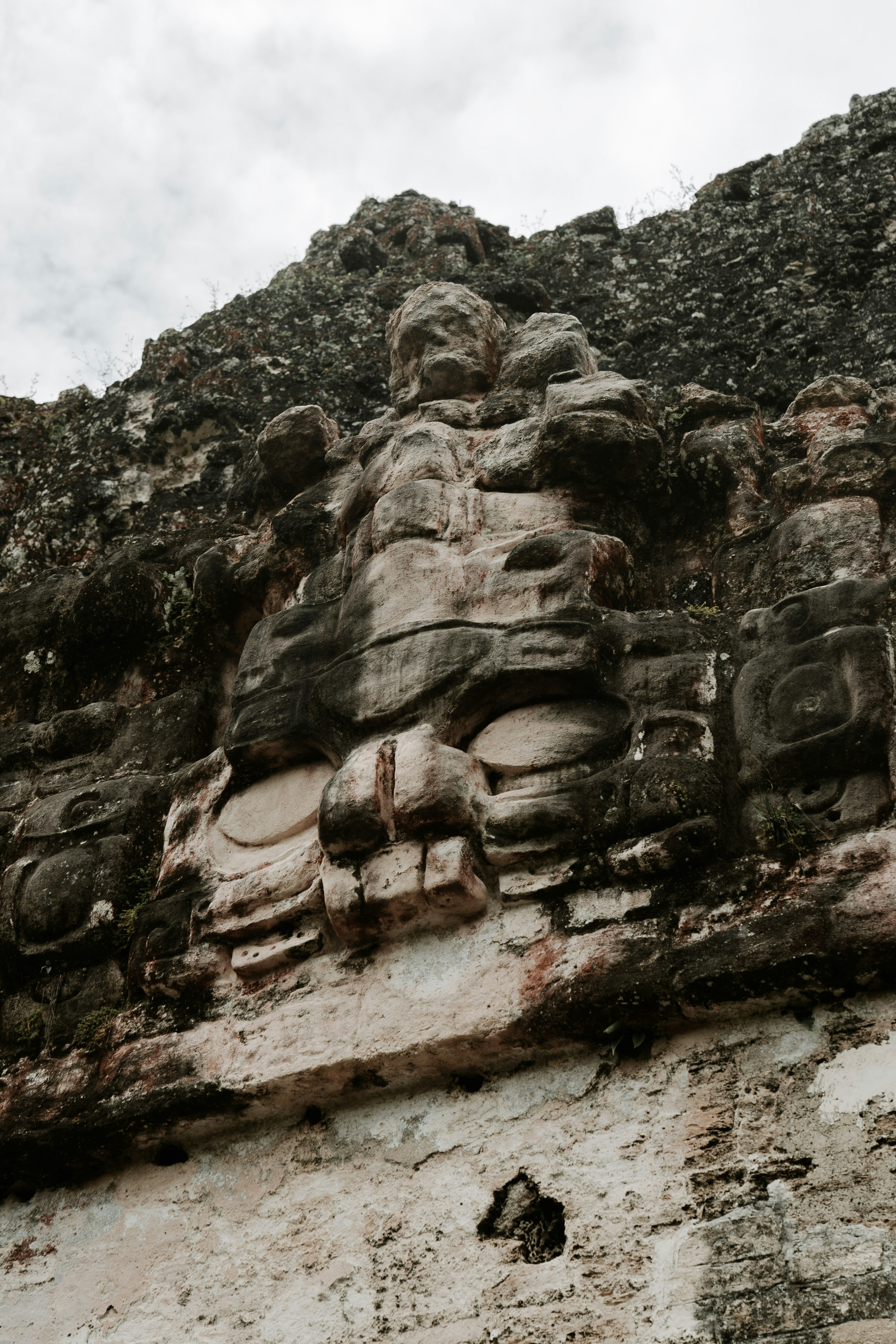 Stone Face of Time: A Weathered Idol Carved into Ancient Ruins