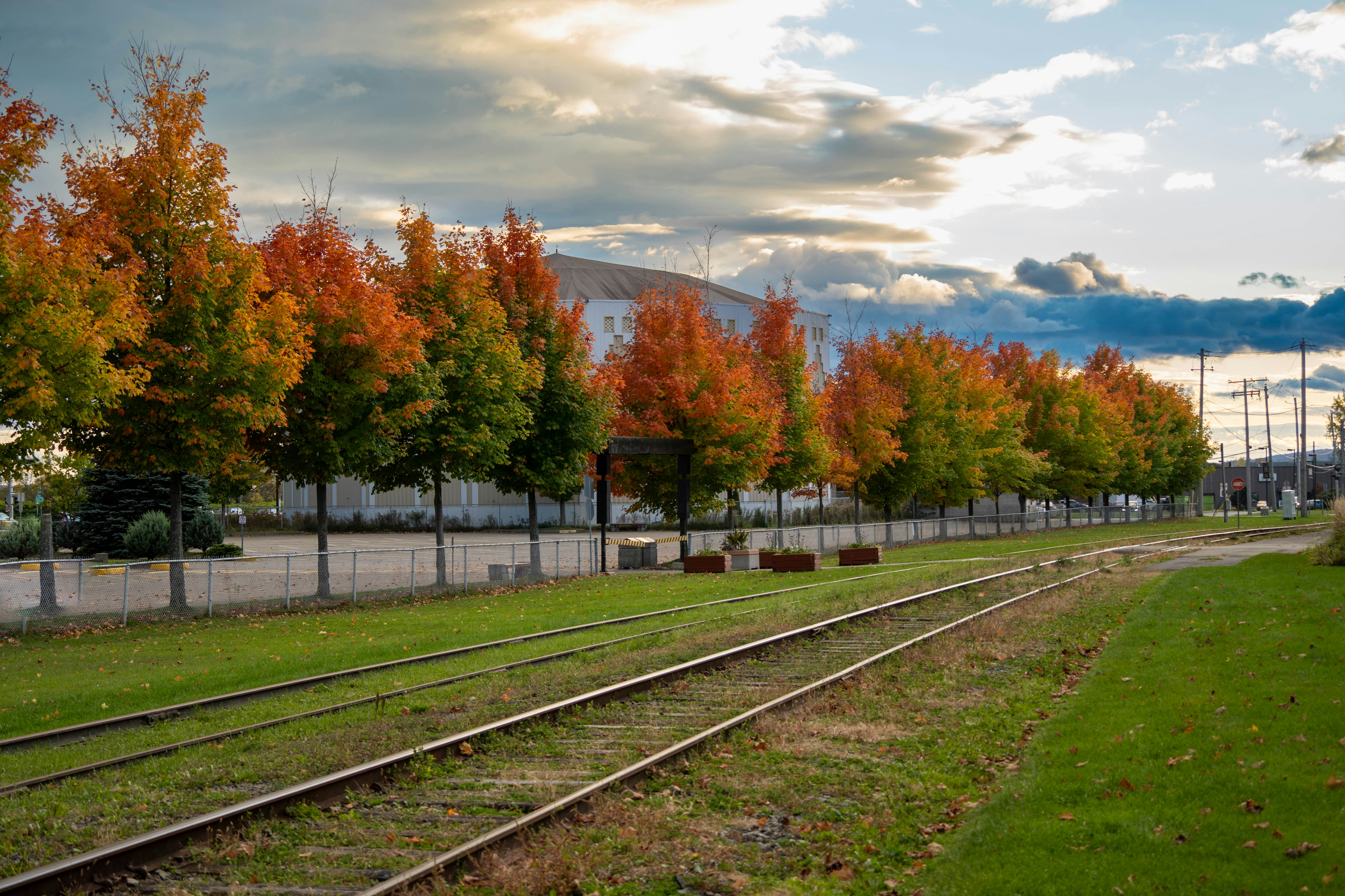 A row of train tracks in front of a building photo – Free Nature Image ...