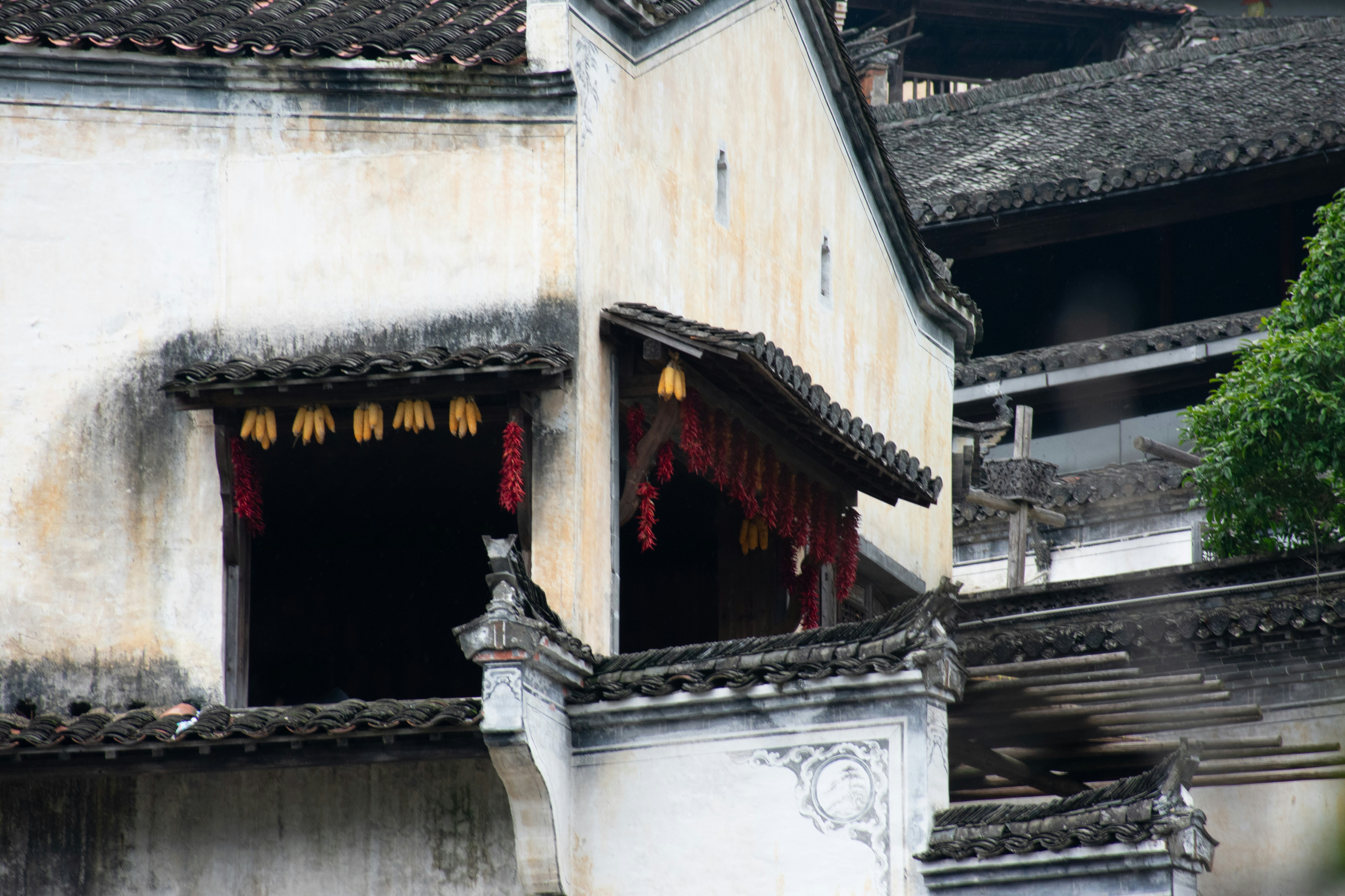 Crimson Lanterns Framing a Weathered Chinese Courtyard Gate
