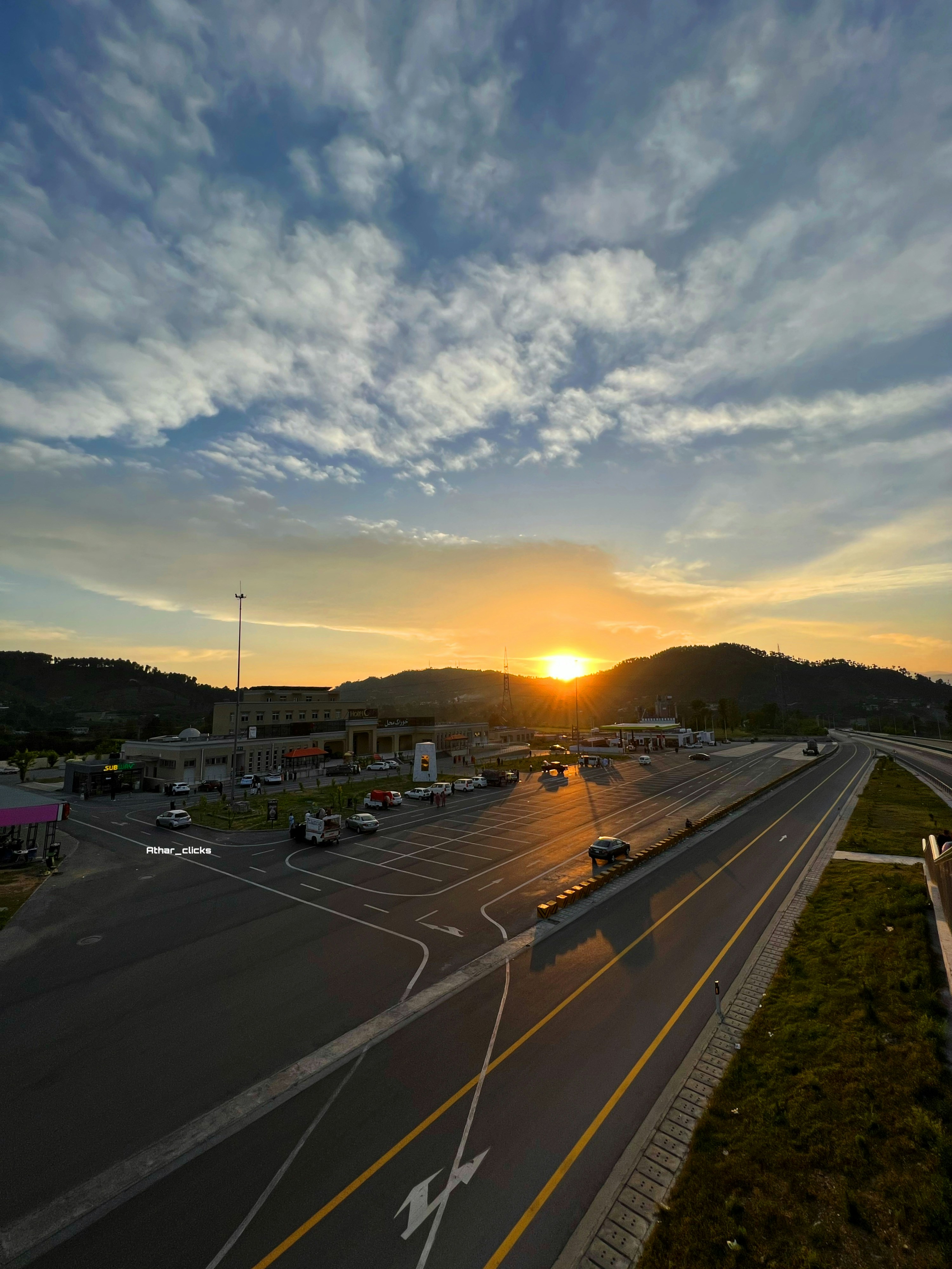 Sunset at the Runway Edge: A Quiet Highway Framing Distant Hills