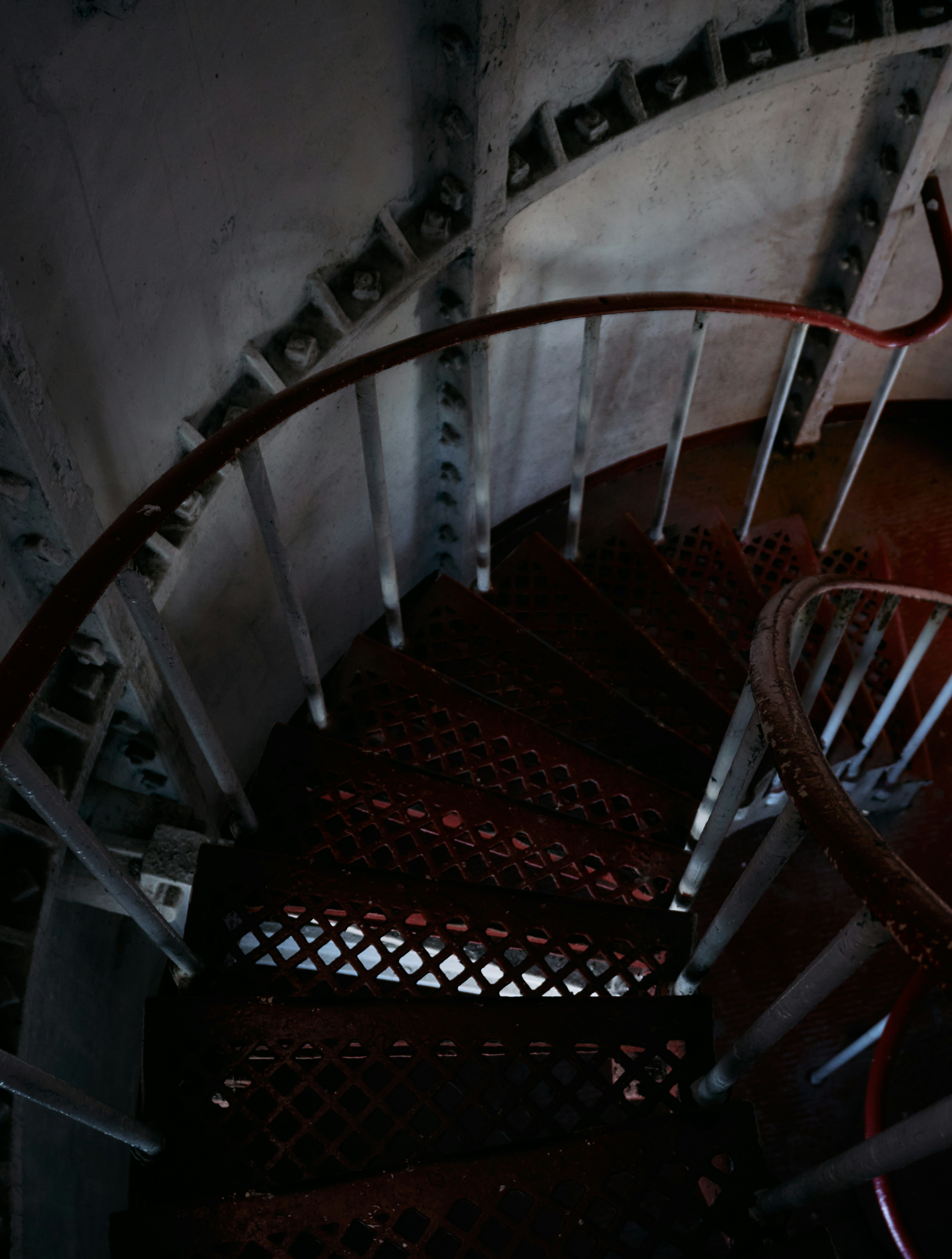 Rust and Spiral: Descending Through a Dim Industrial Staircase