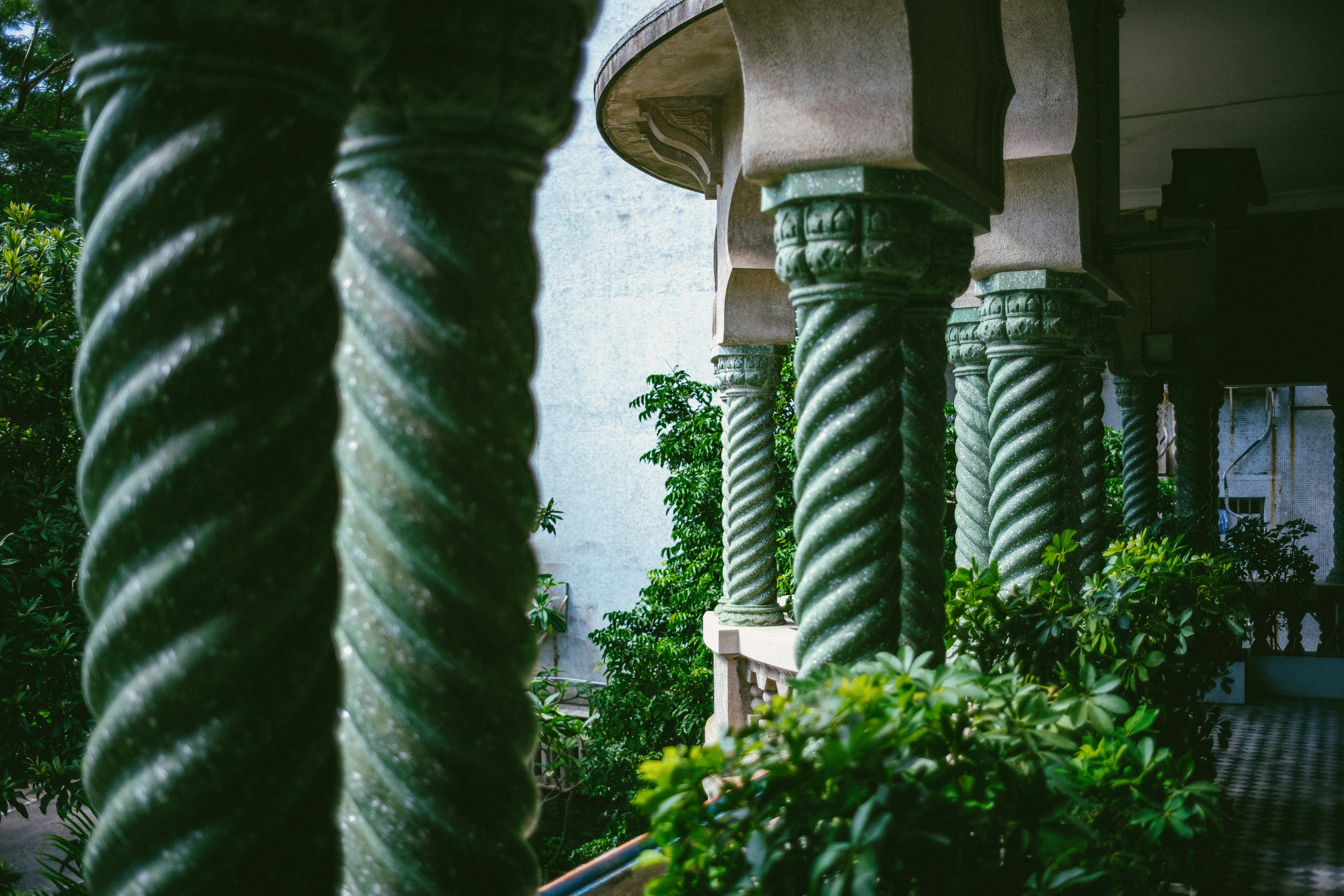 Emerald Spiral Columns Framing a Quiet Veranda