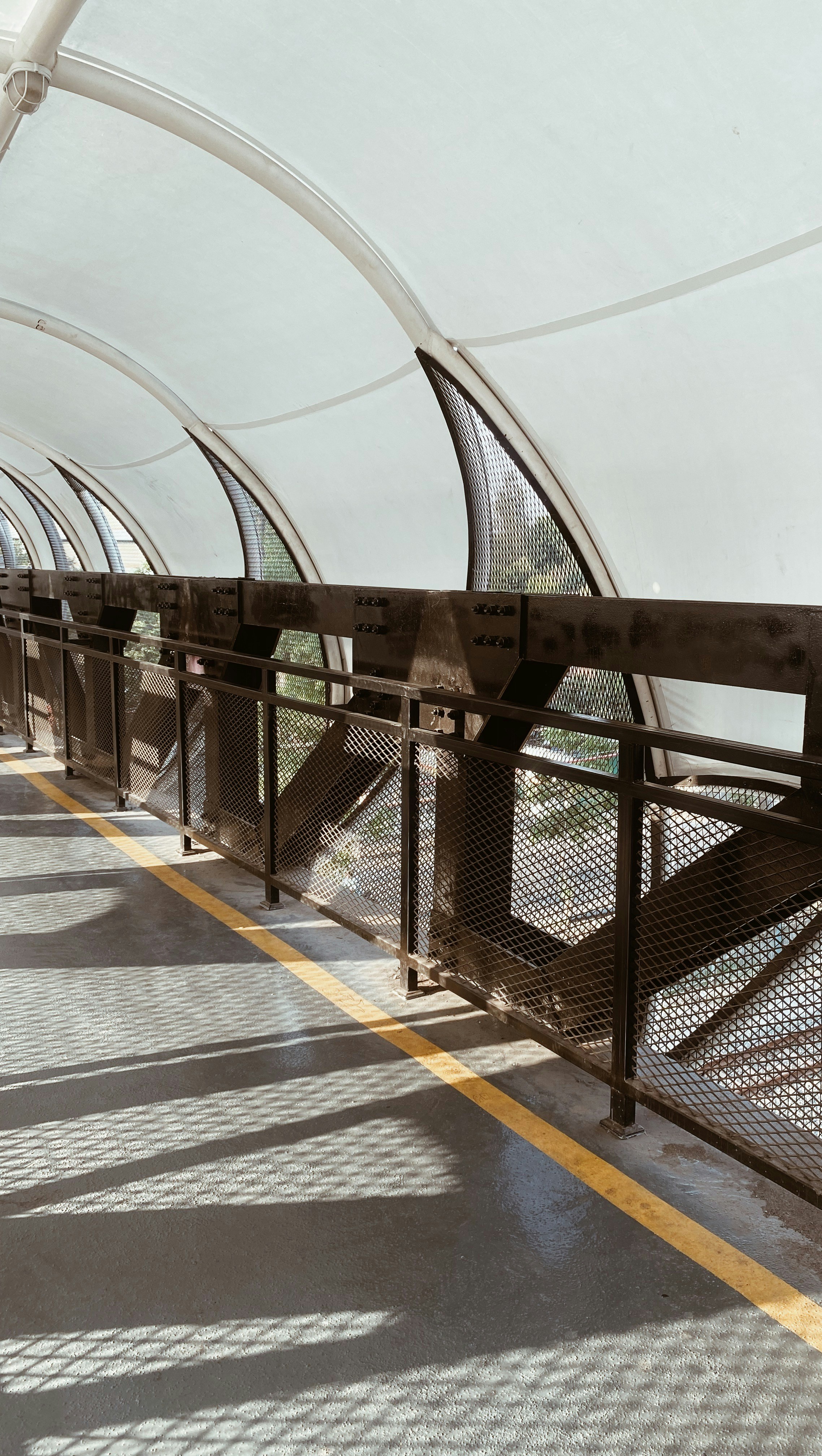A walkway with metal railings and a yellow line photo – Free Manahan ...