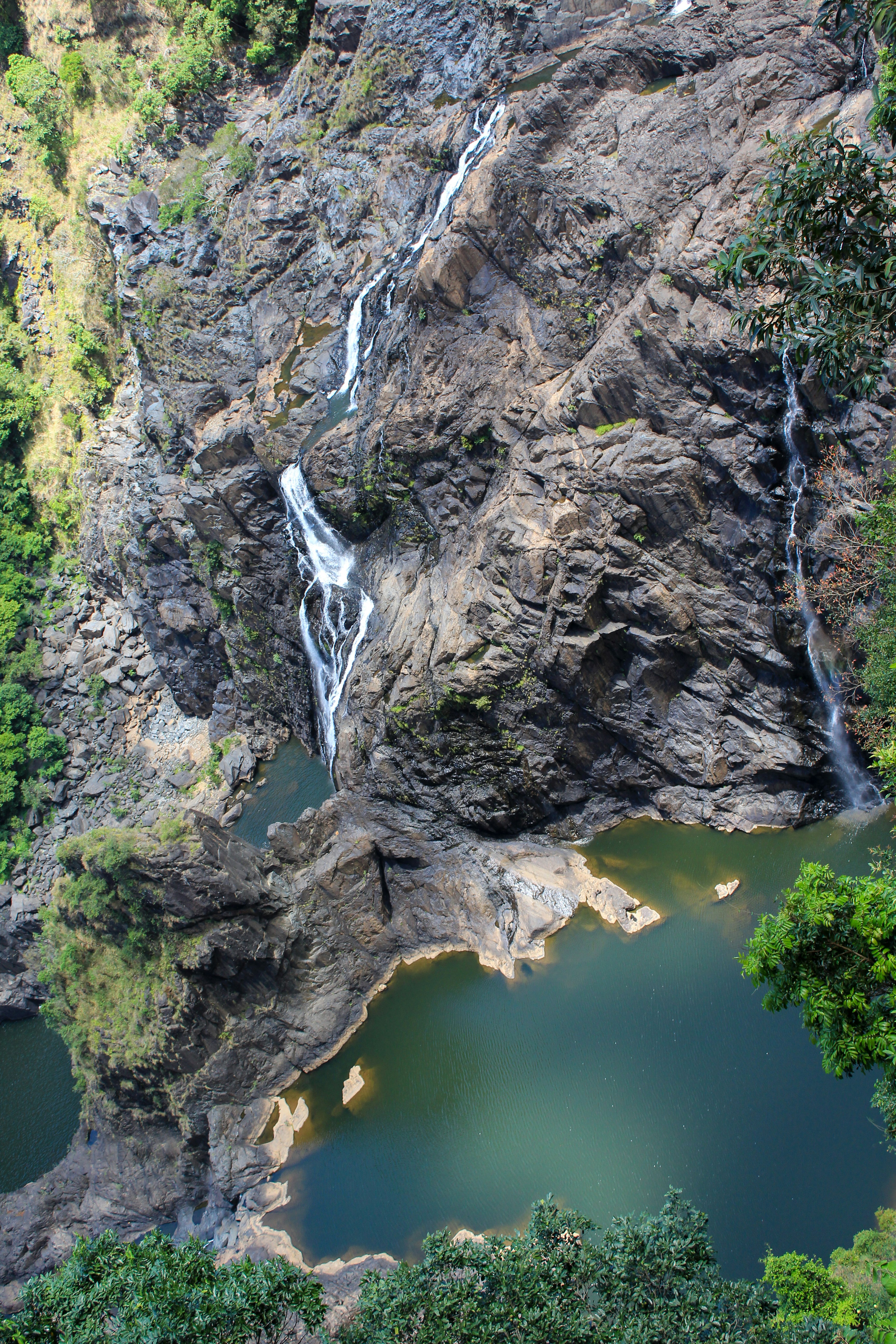 An aerial view of a waterfall and a lake photo – Free Waterfall Image ...