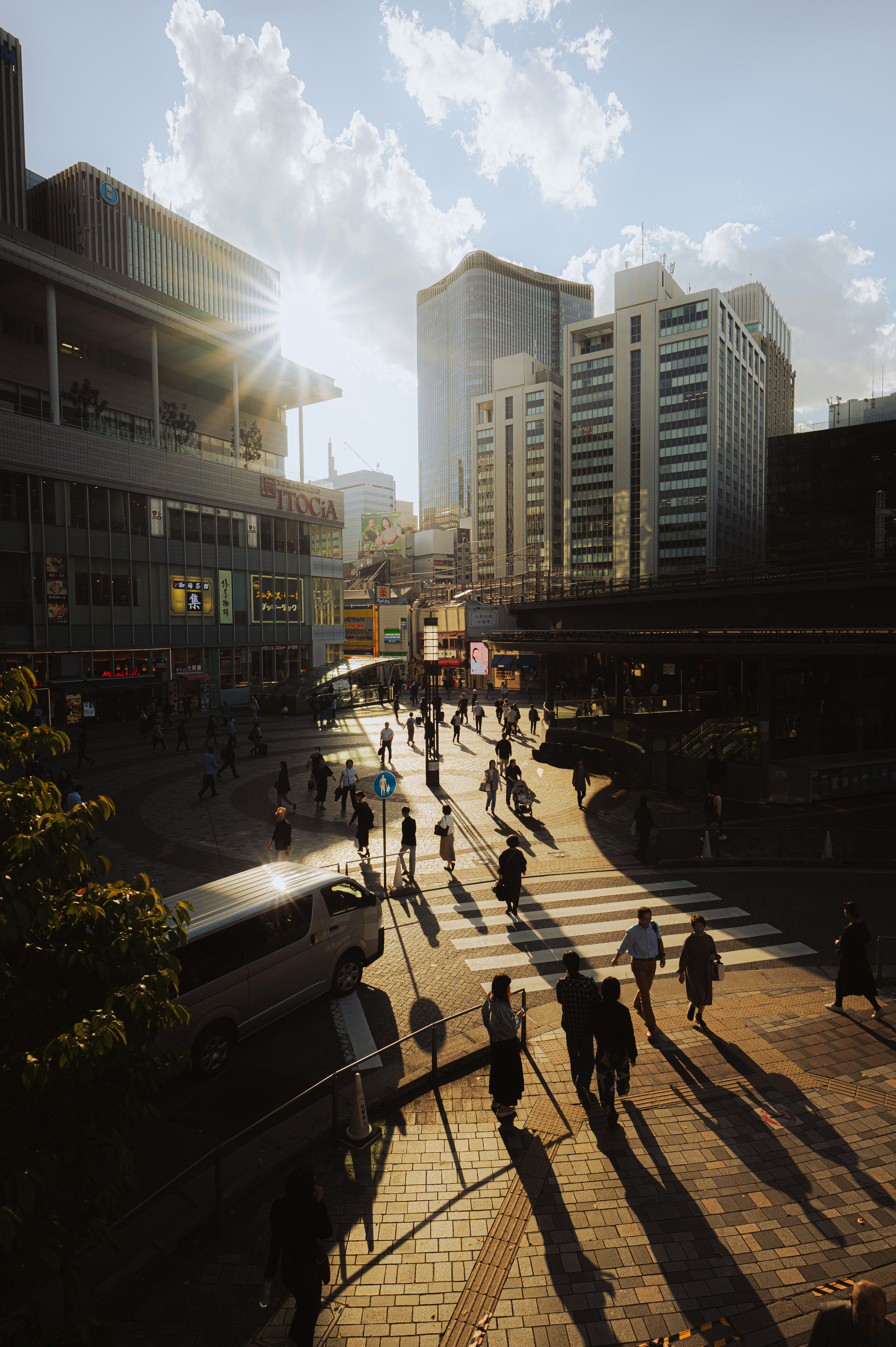 Sunlit Crosswalk Mosaic: Pedestrian Flow Beneath a Glass City Canyon