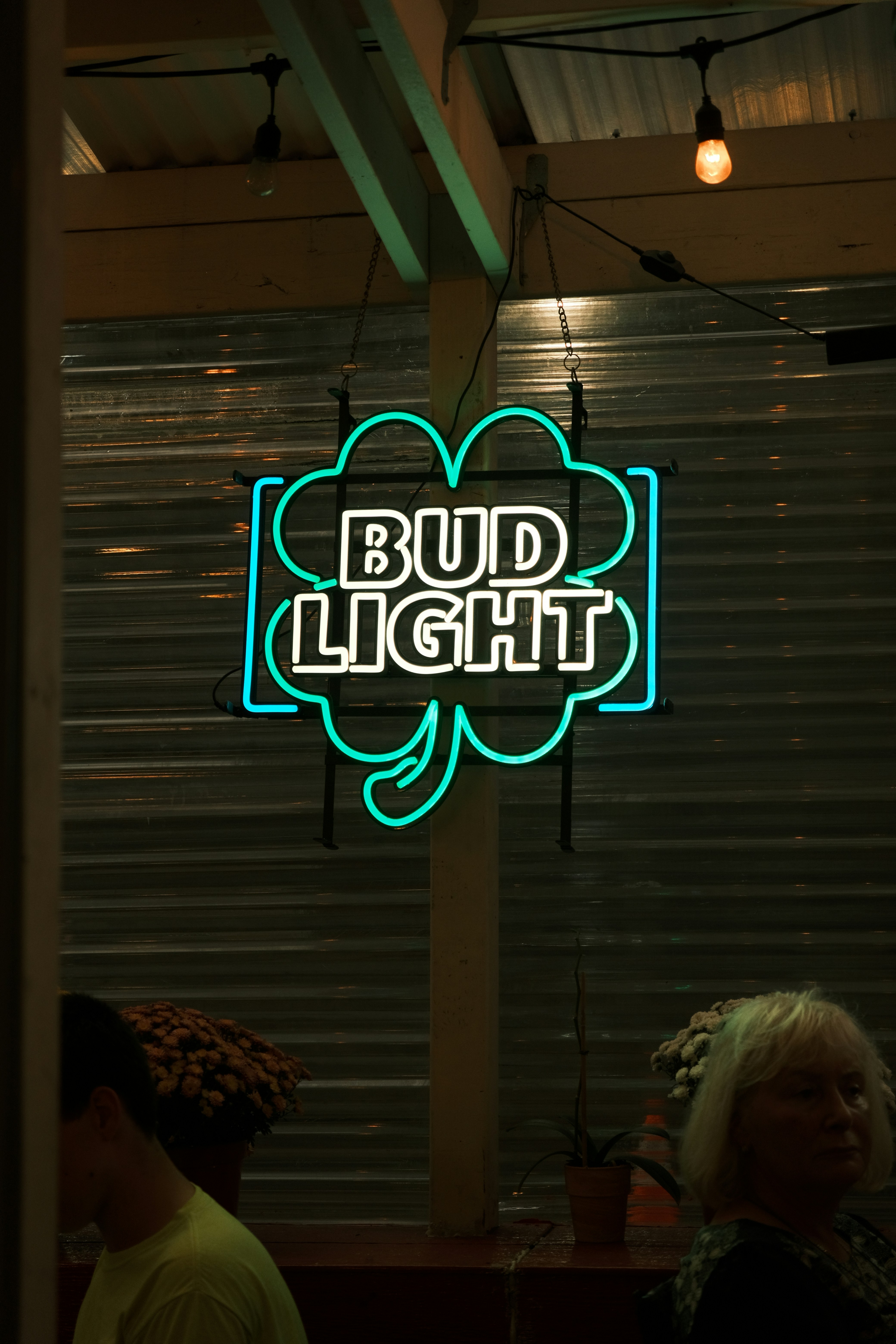 Emerald Neon Bud Light Shamrock Illuminates a Dim Corner