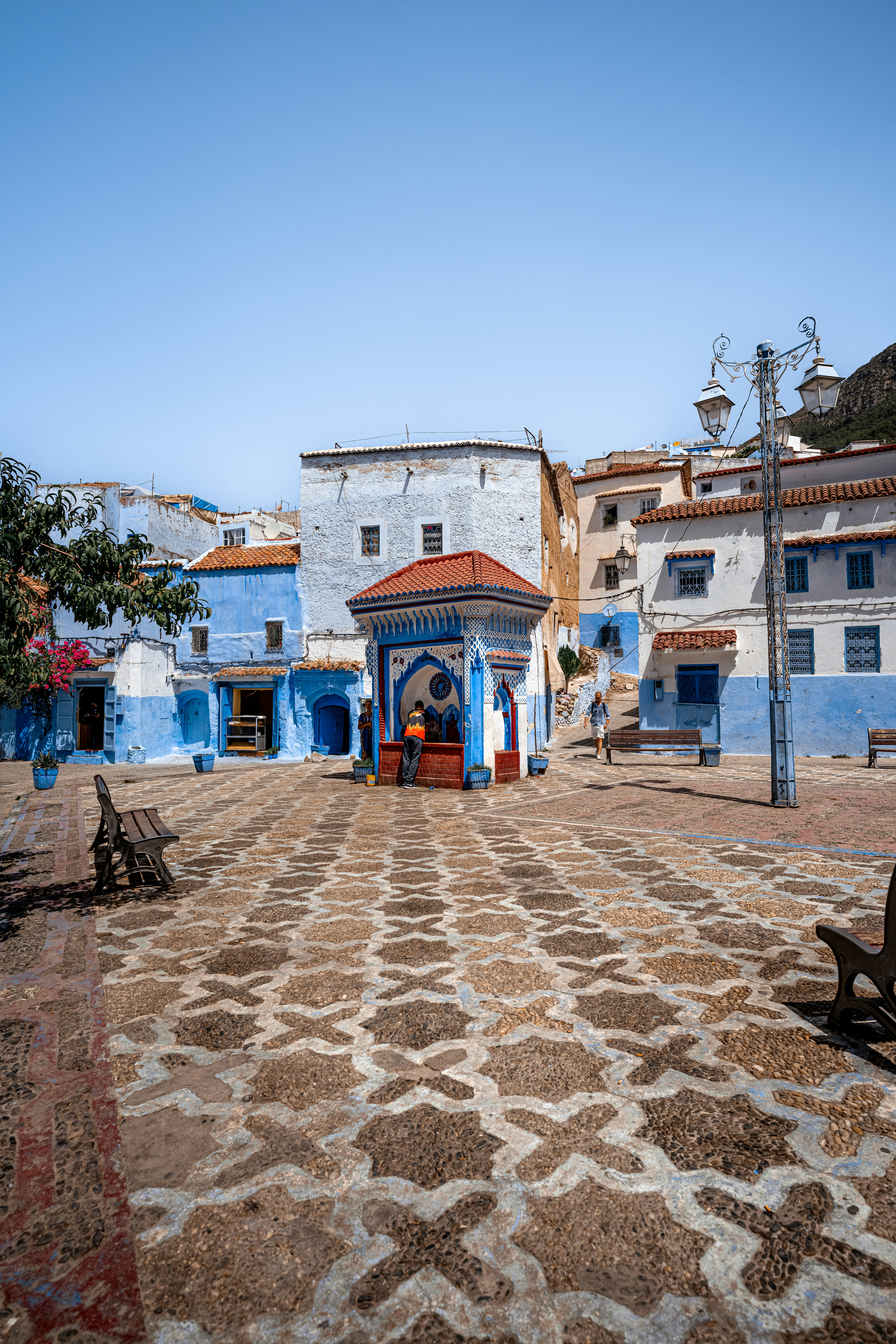 A cobblestone street with a blue building in the background photo ...