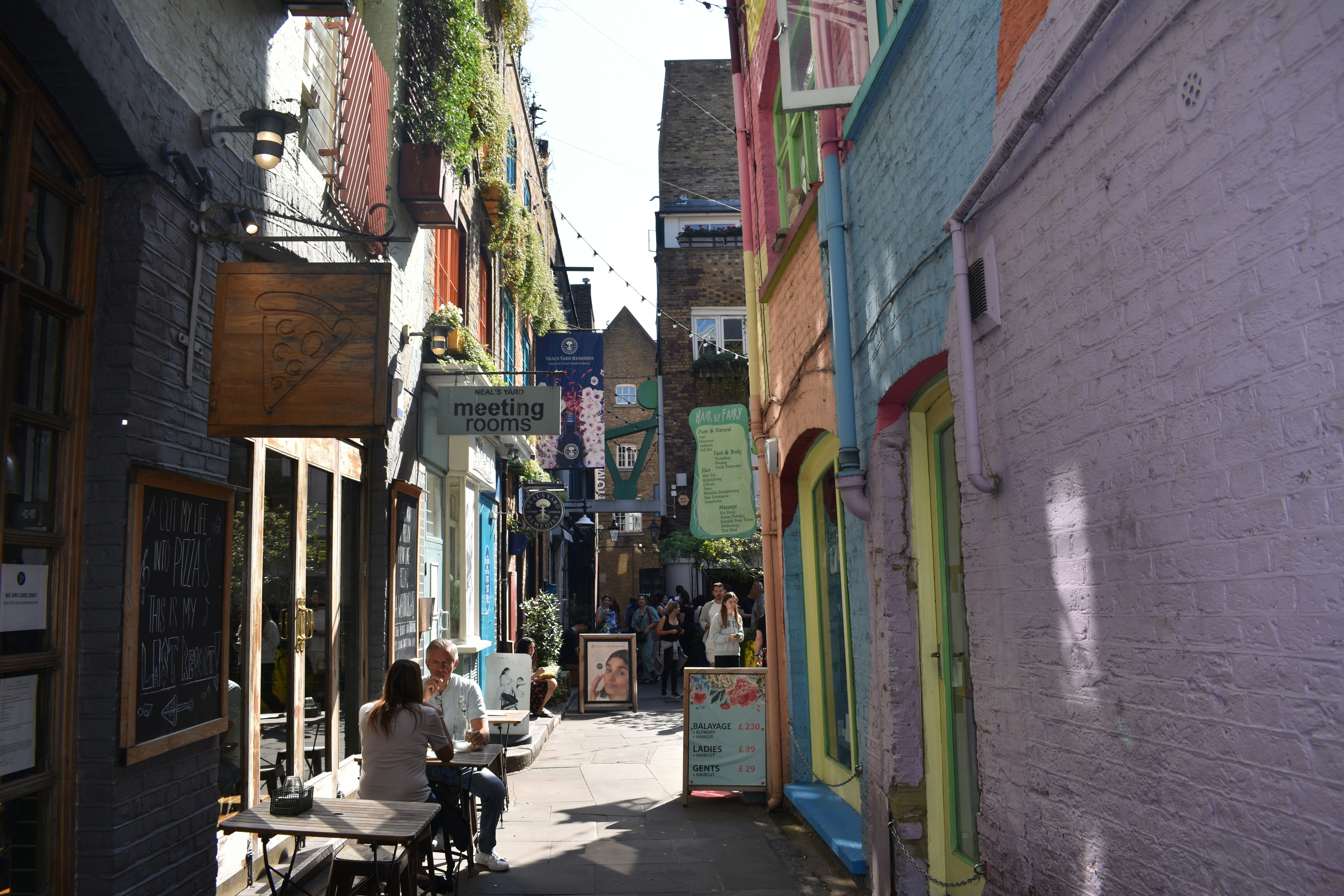 Colorful Alleyway Café Scene with People at a Narrow Street