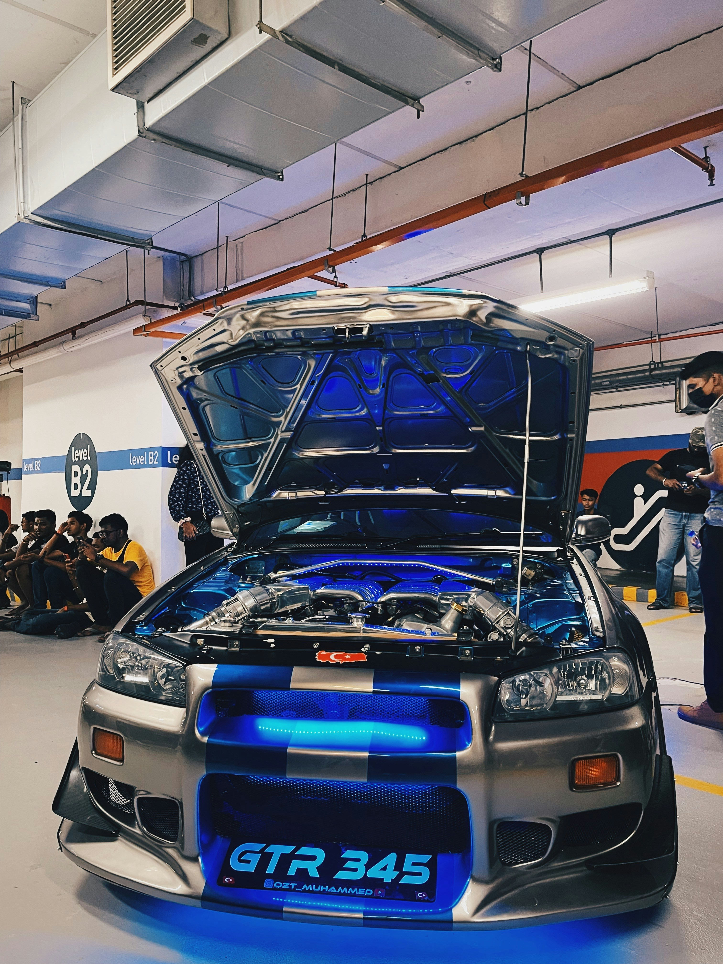 A car with its hood open in a garage photo – Free Car Image on Unsplash