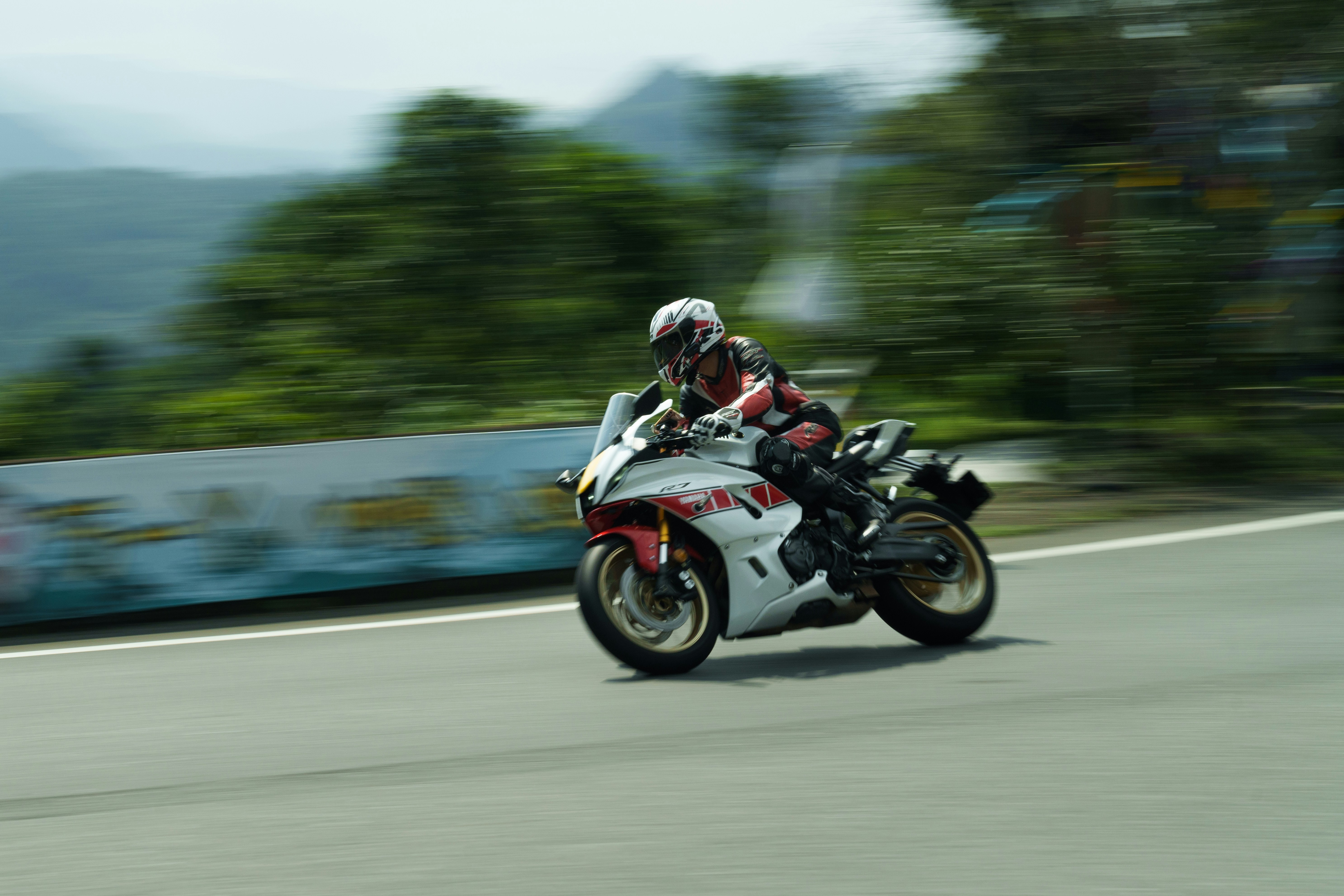 A man riding a motorcycle down a curvy road photo – Free Taiwan Image ...