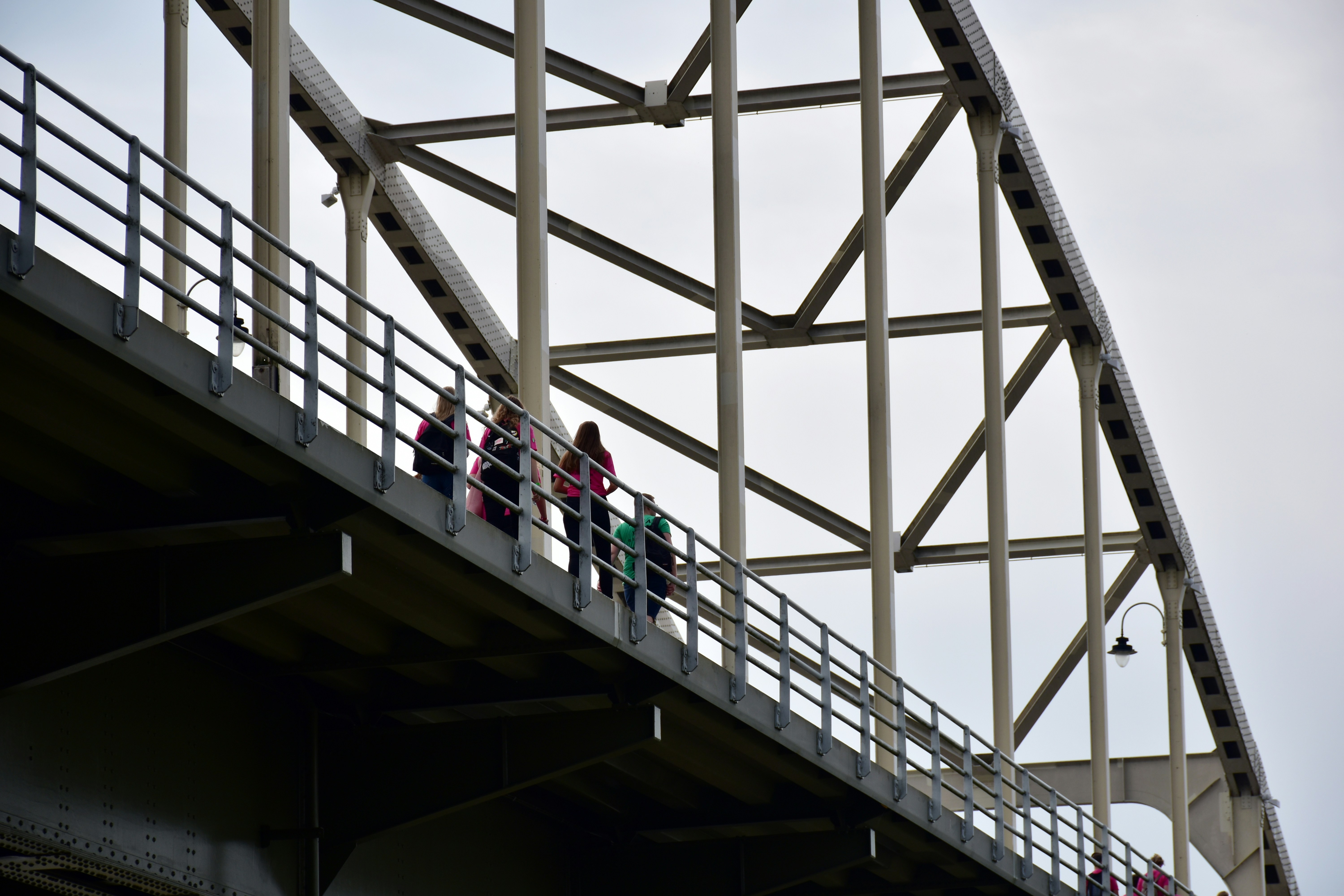A group of people walking across a bridge photo – Free Deventer Image ...