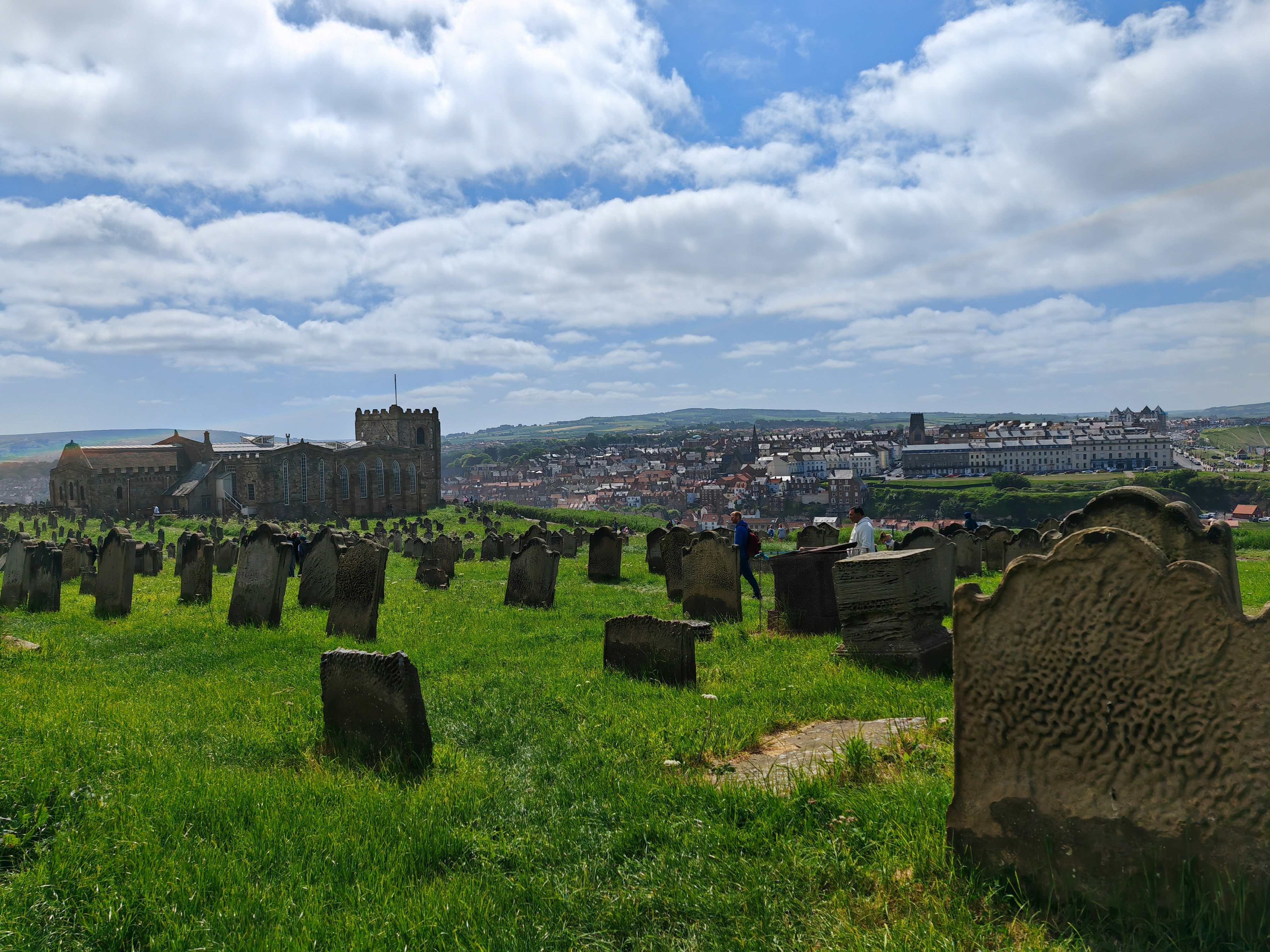 A cemetery with a view of a city in the distance photo – Free Whitby ...