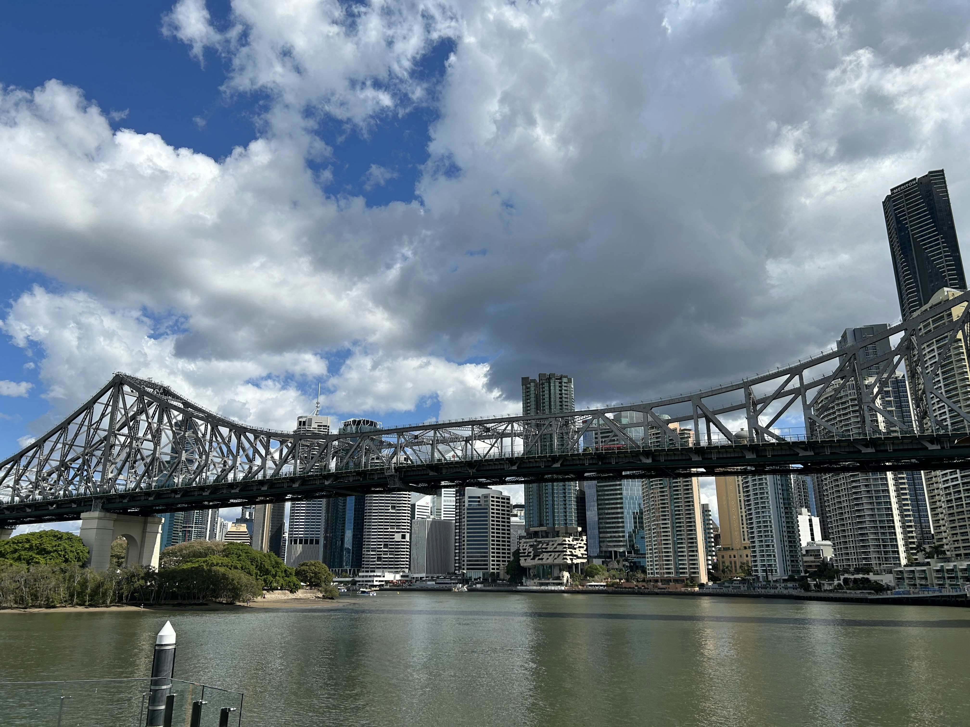 Steel Ribbon Over Brisbane River: Skyline Framed by a Cloudscape