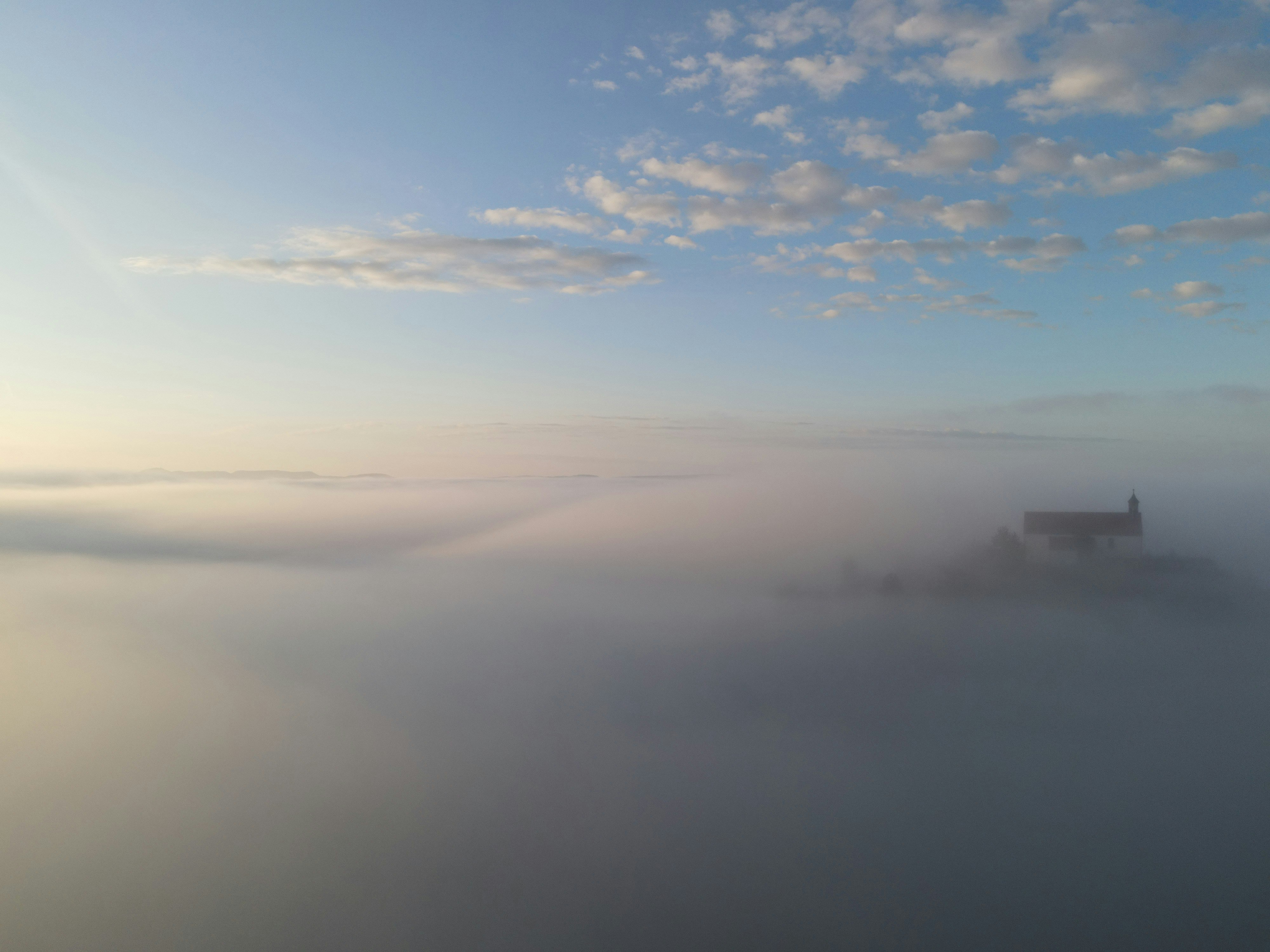 Dawn Over the Fog Sea: A Solitary Cabin Emerges