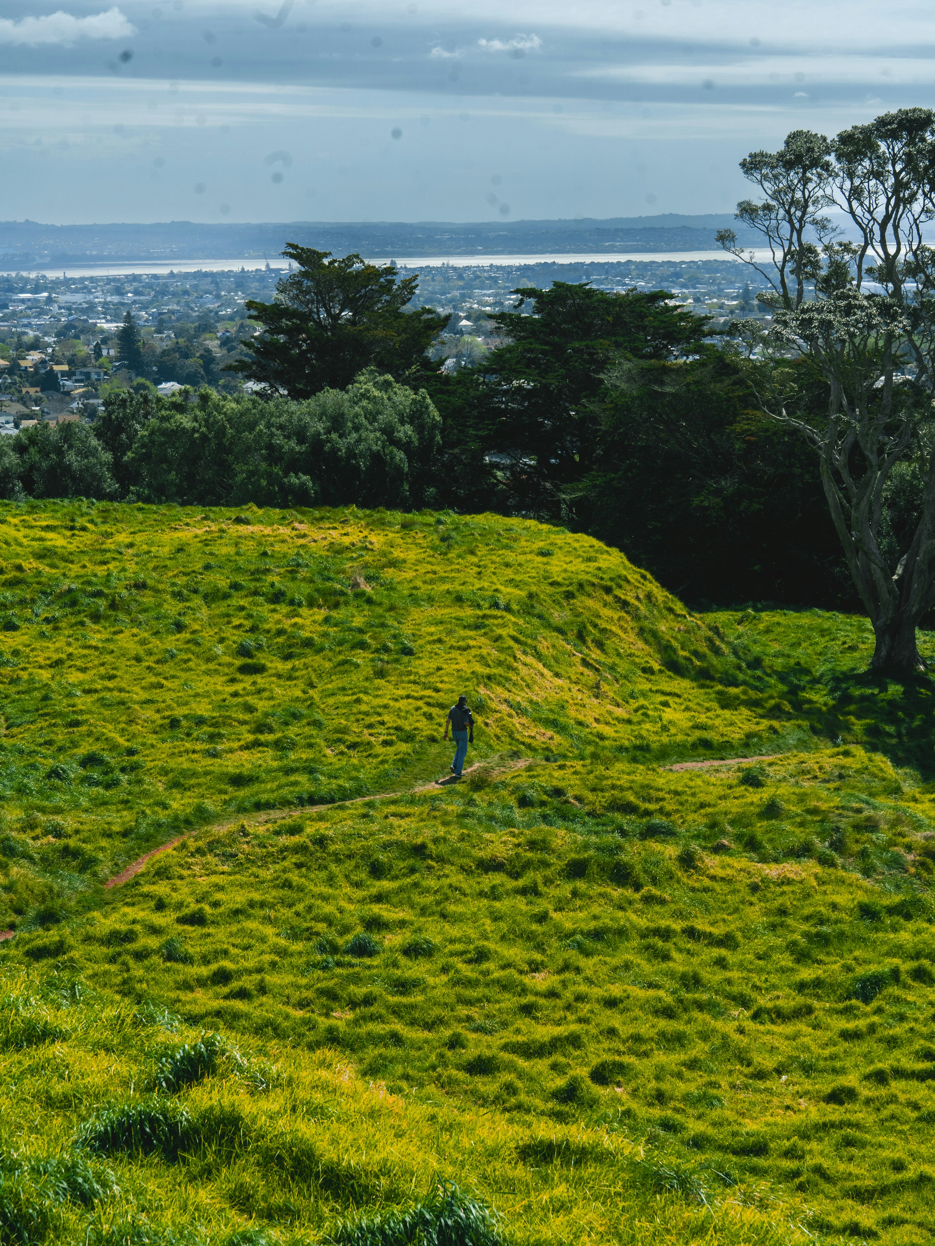 Lonely Wanderer on a windswept hill under a vast blue sky