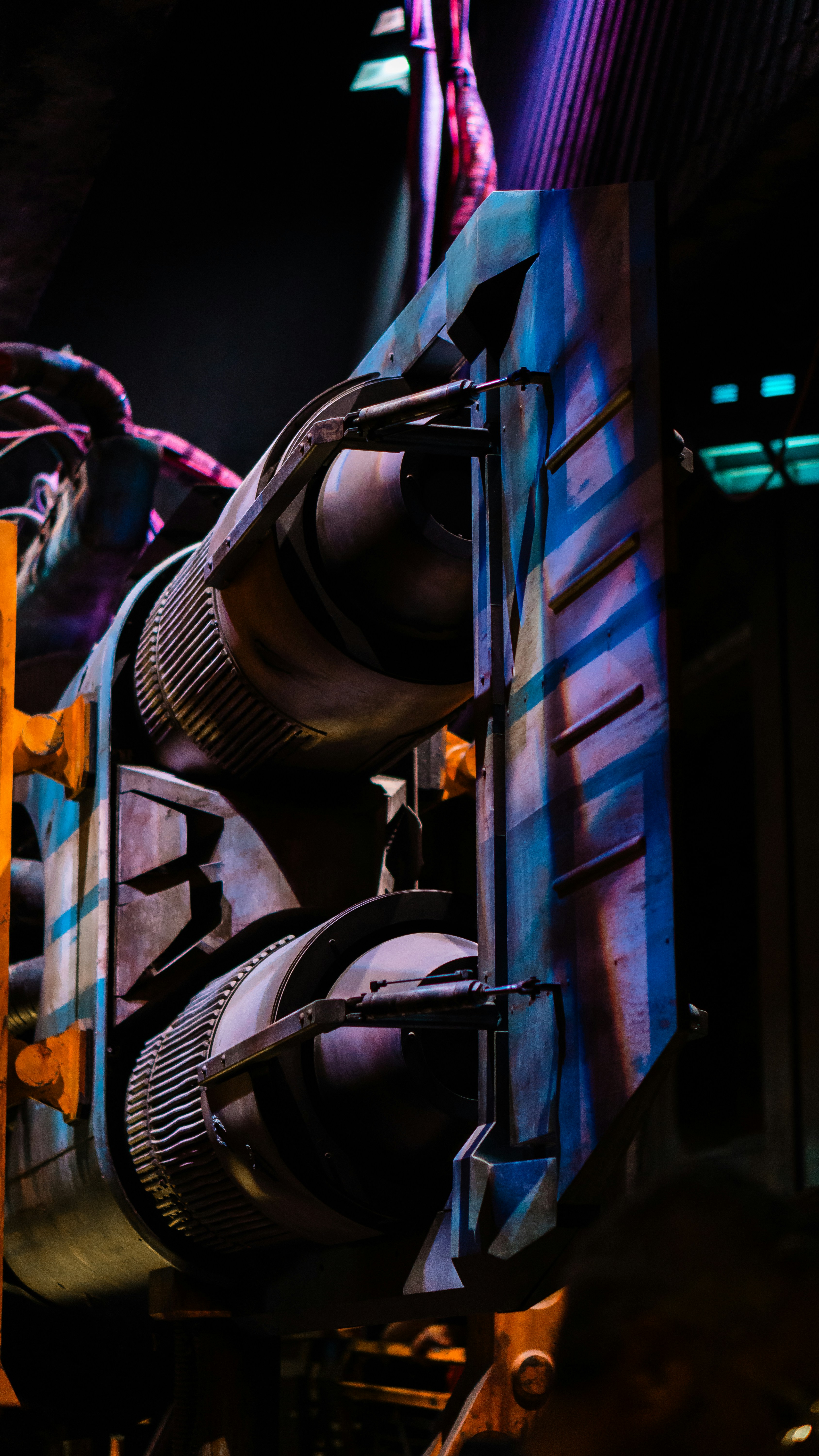 Neon-tinged turbine array under a moody industrial glow