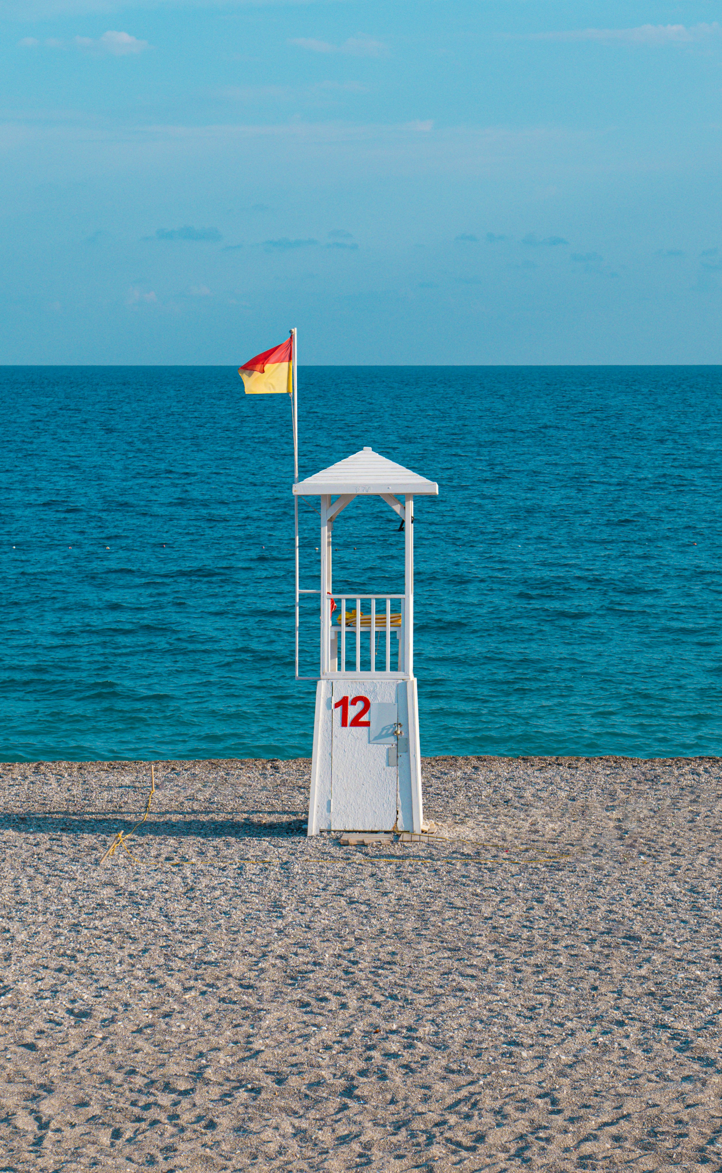A lifeguard stand on the beach with a flag flying photo – Free Antalya ...