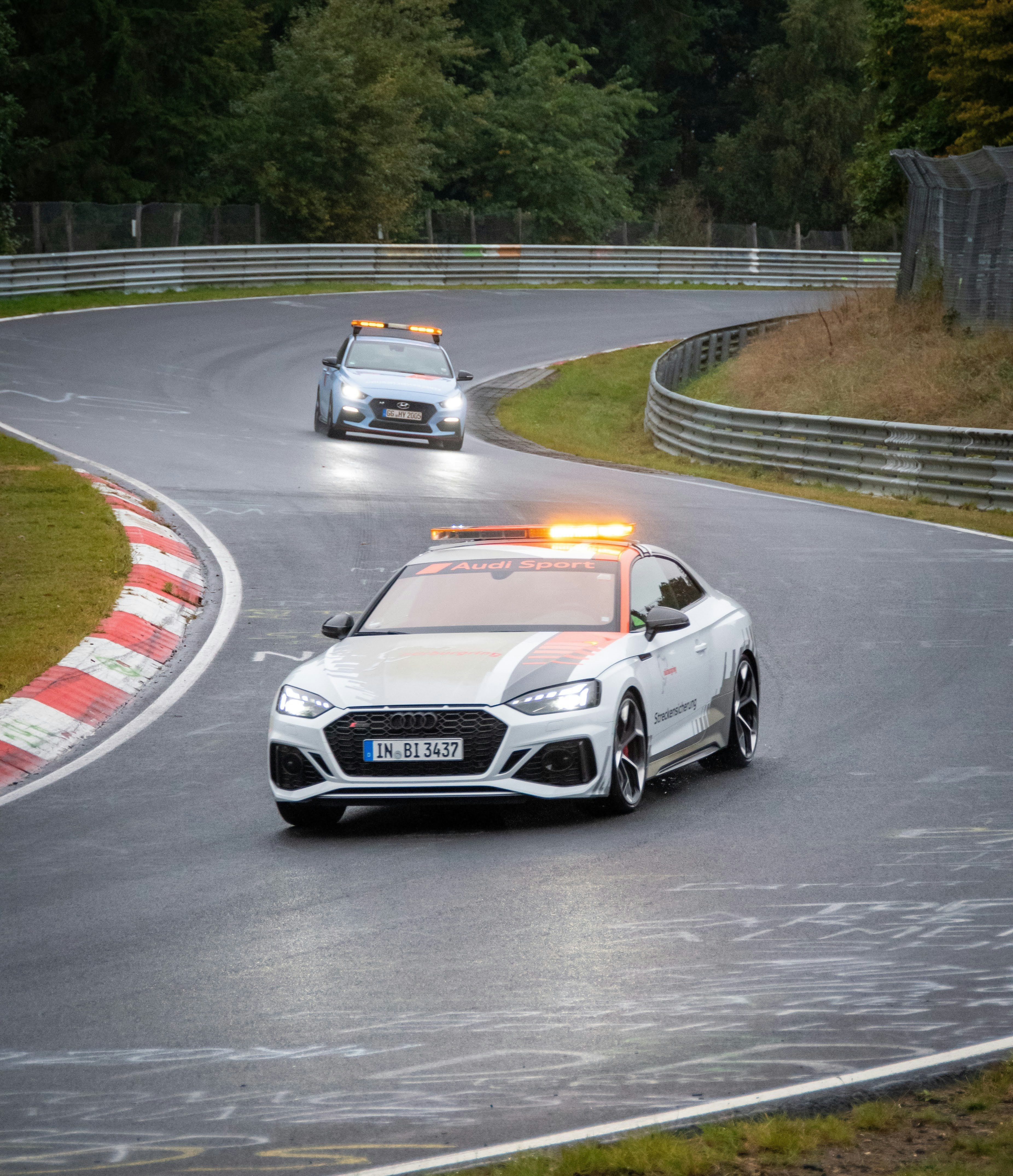 A police car driving down a race track photo – Free Germany Image on ...