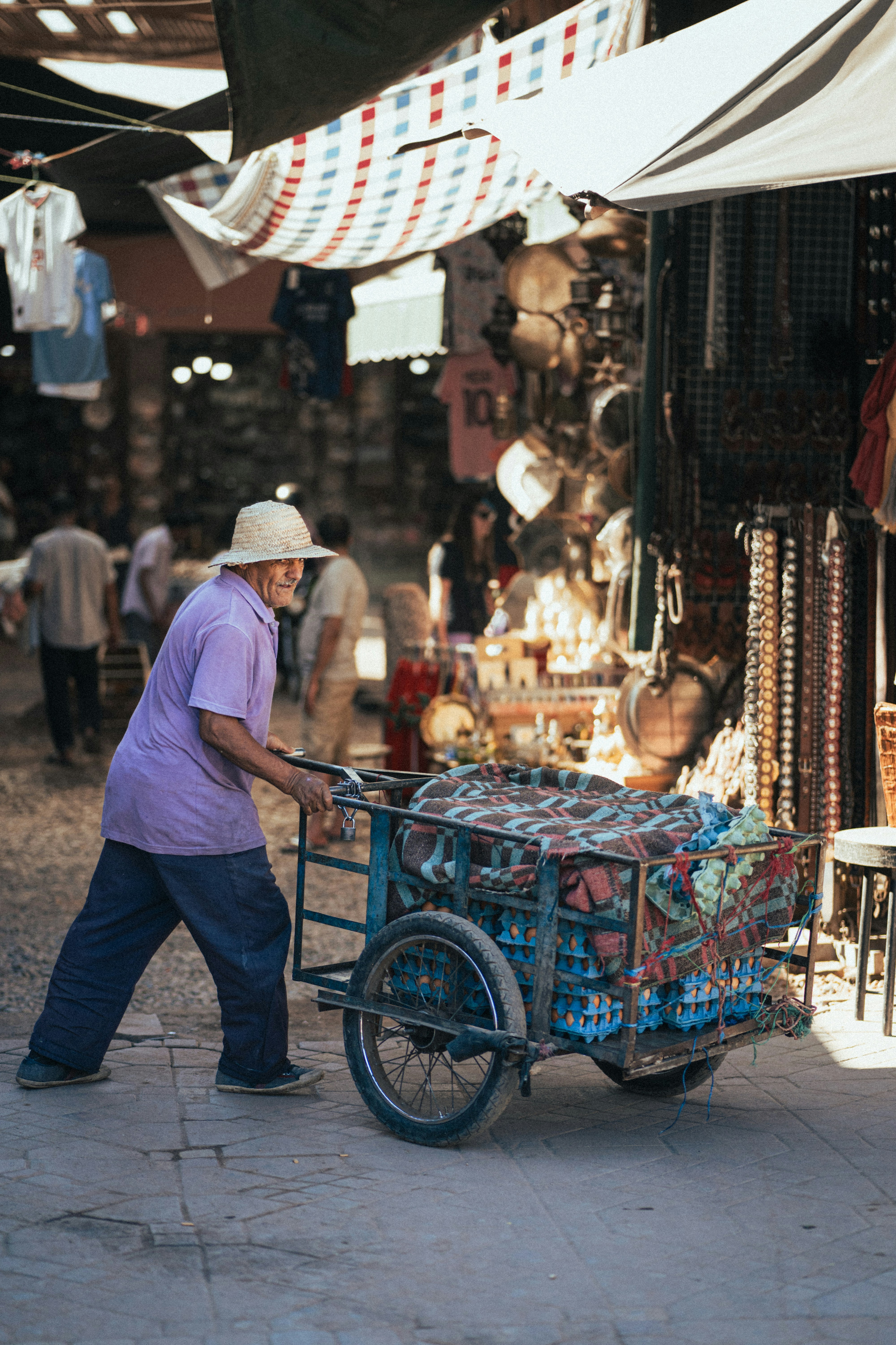 A man pushing a cart filled with lots of items photo – Free Marrakech ...
