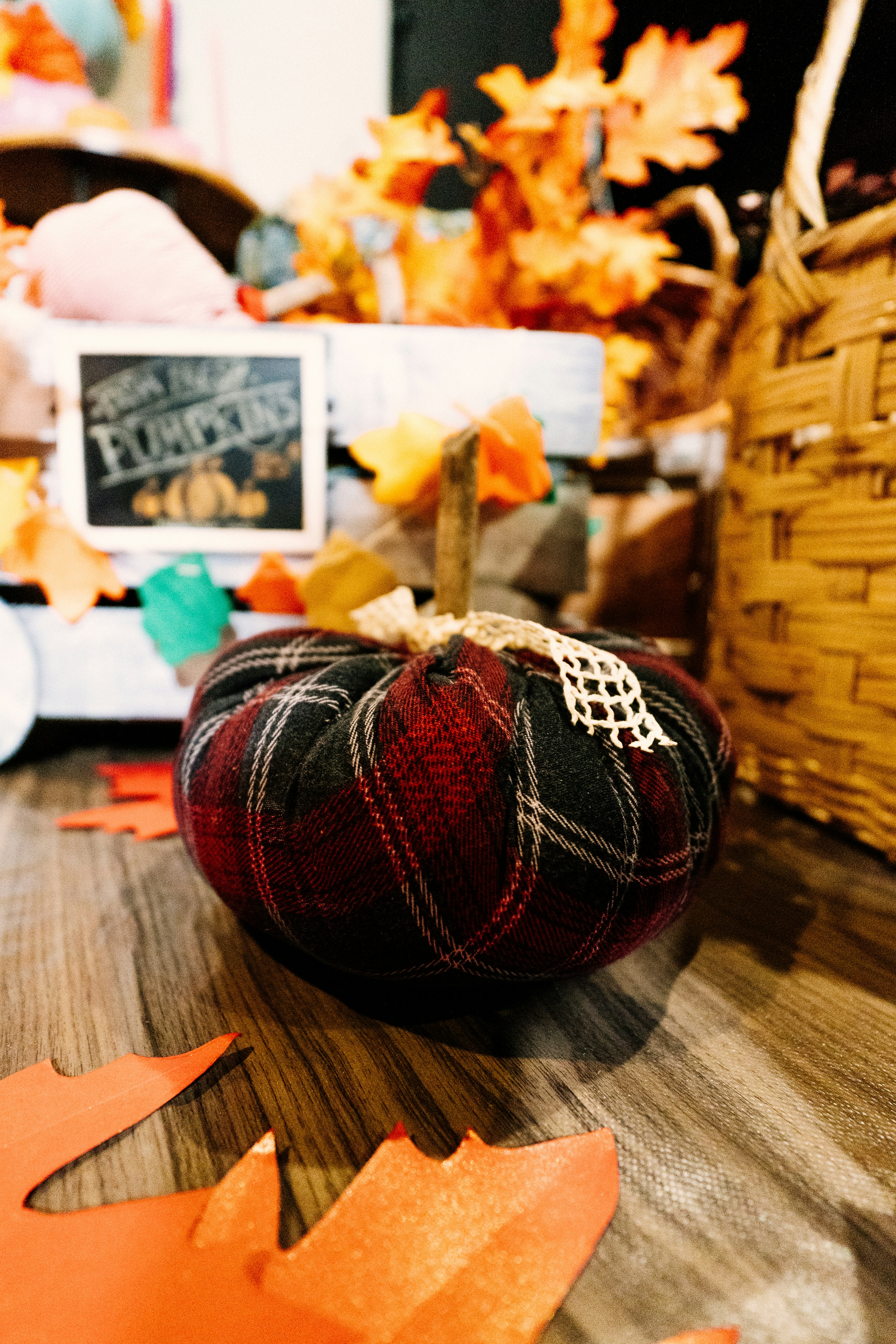 Plaid Pumpkin Still Life: Autumn Warmth on a Wooden Floor