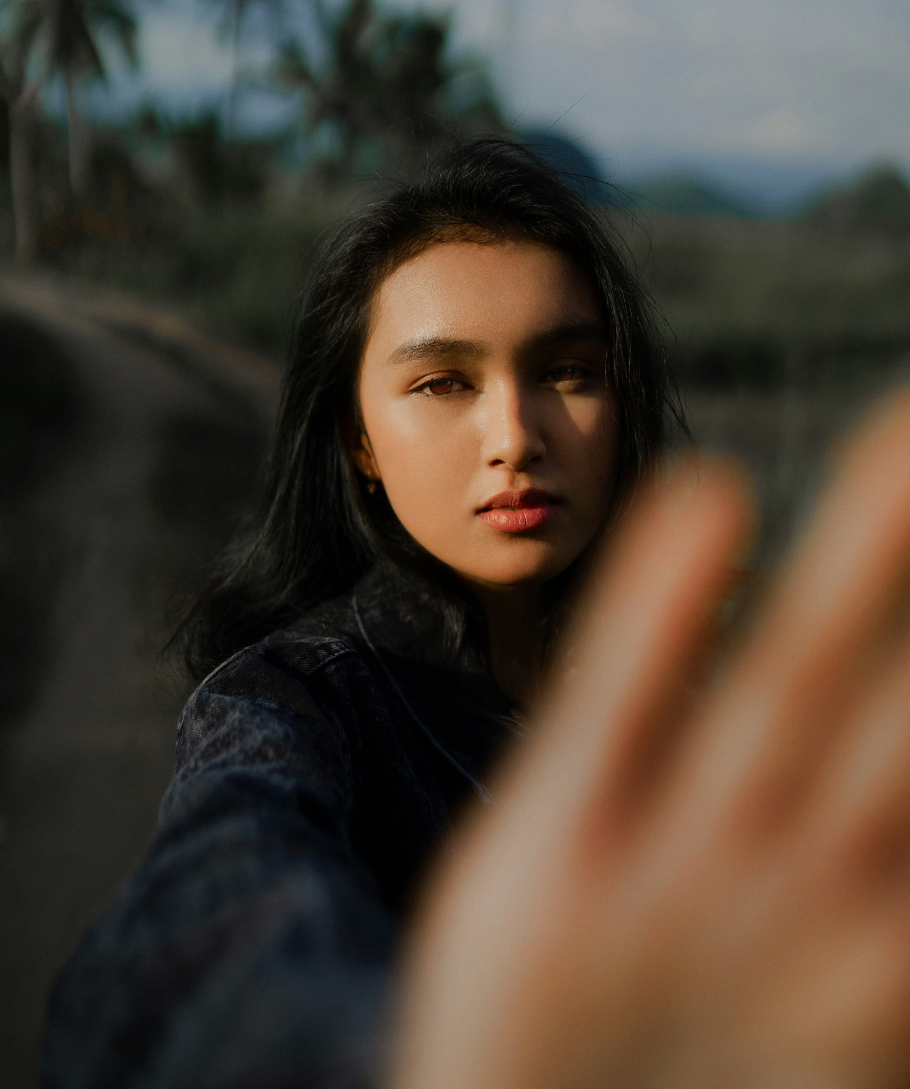 Gaze in Focus, Hand in Frame: A Portrait with Foreground Blur