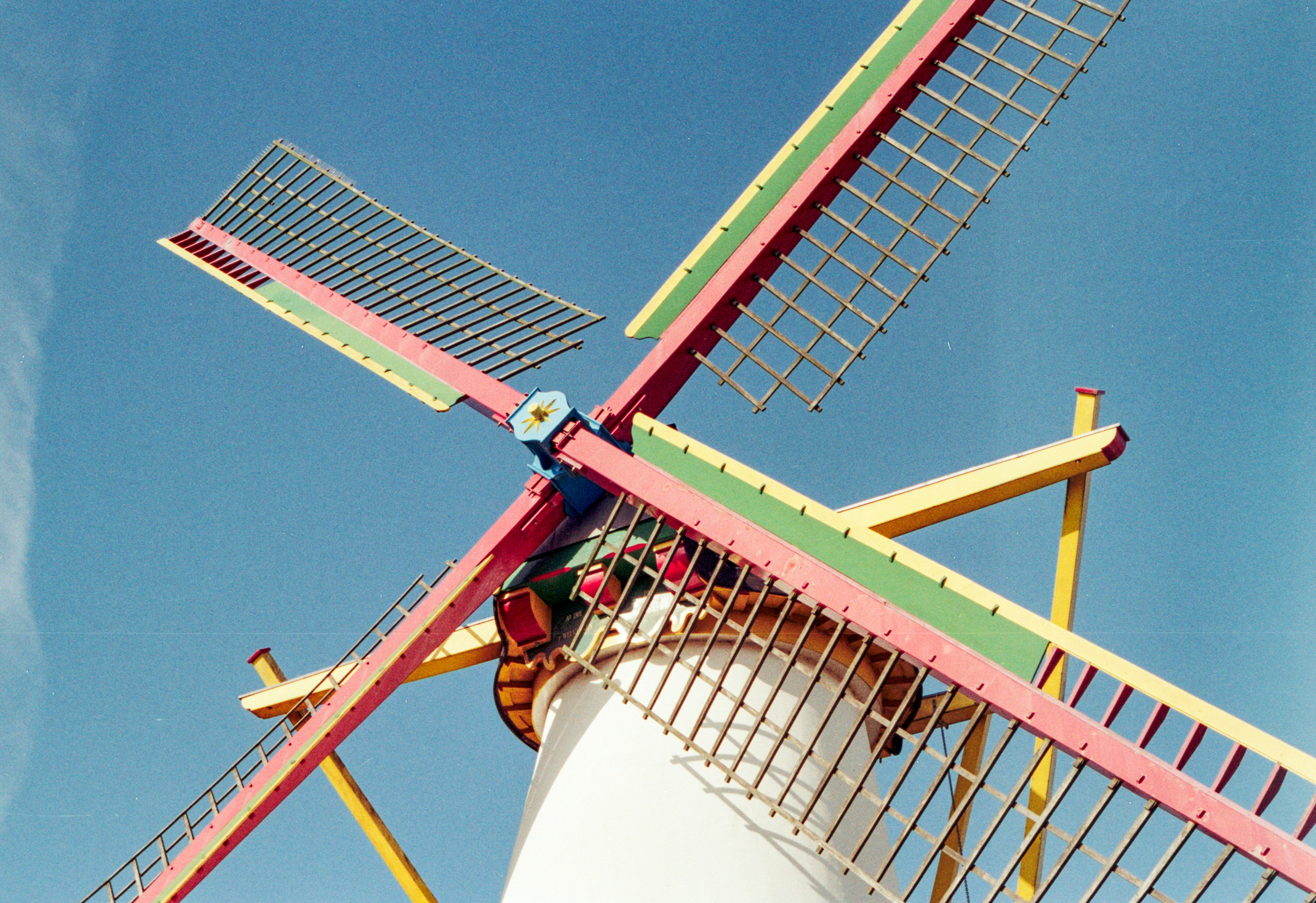 Pastel Lattice Windmill Against a Clear Blue Sky