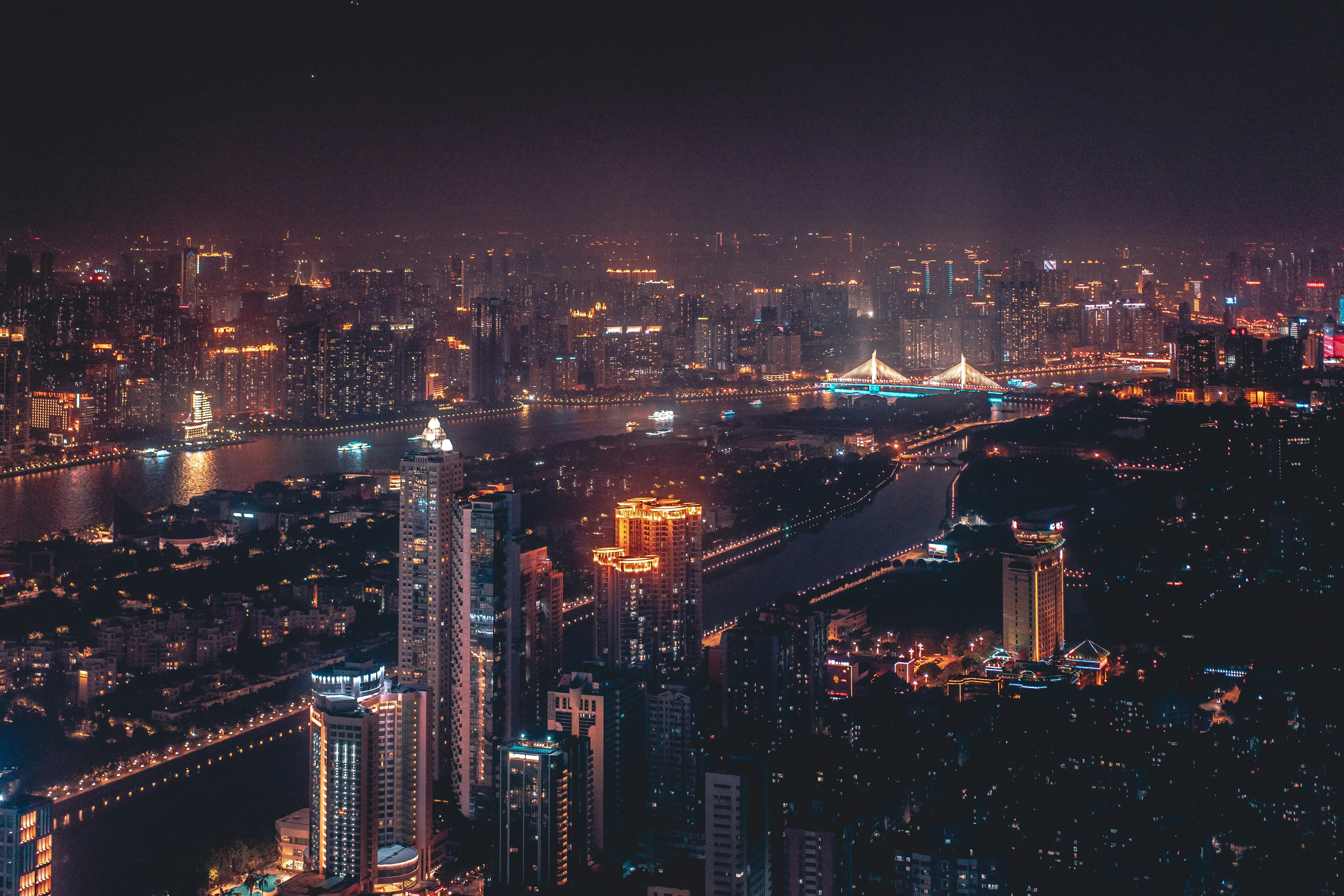 A view of a city at night from the top of a building photo – Free Guangzhou Image on Unsplash