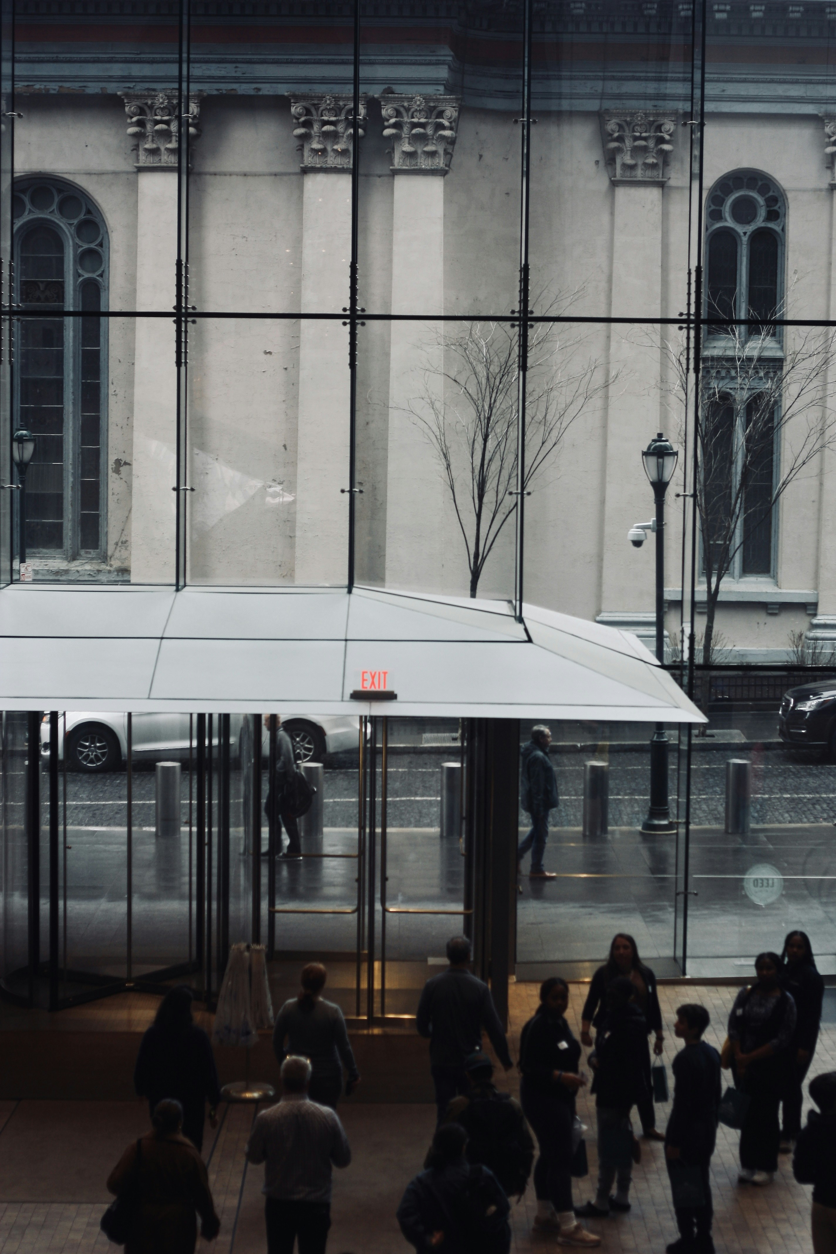 A group of people standing outside of a building photo – Free Pa Image ...