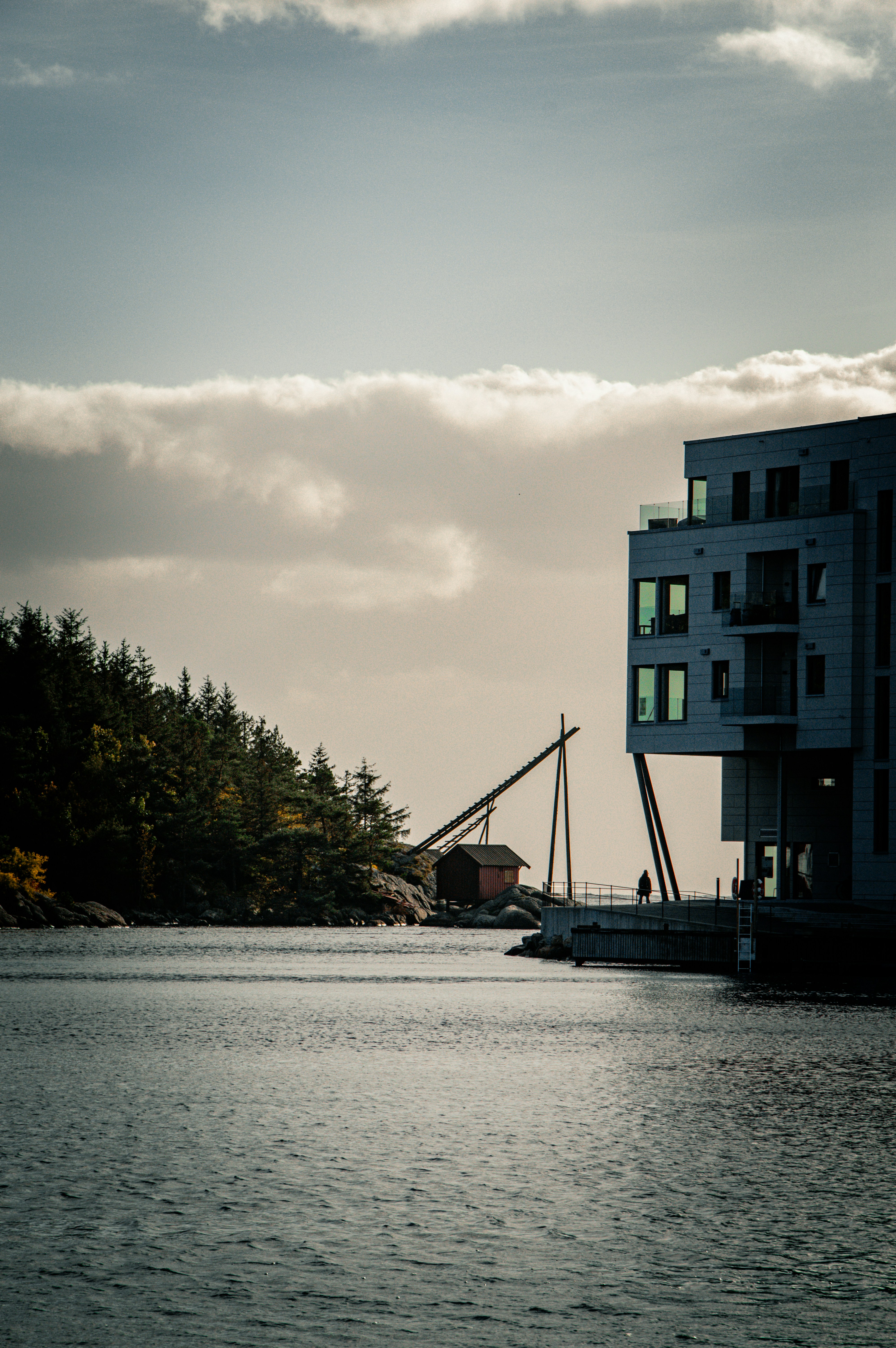 A large building sitting on top of a body of water photo – Free Boat ...