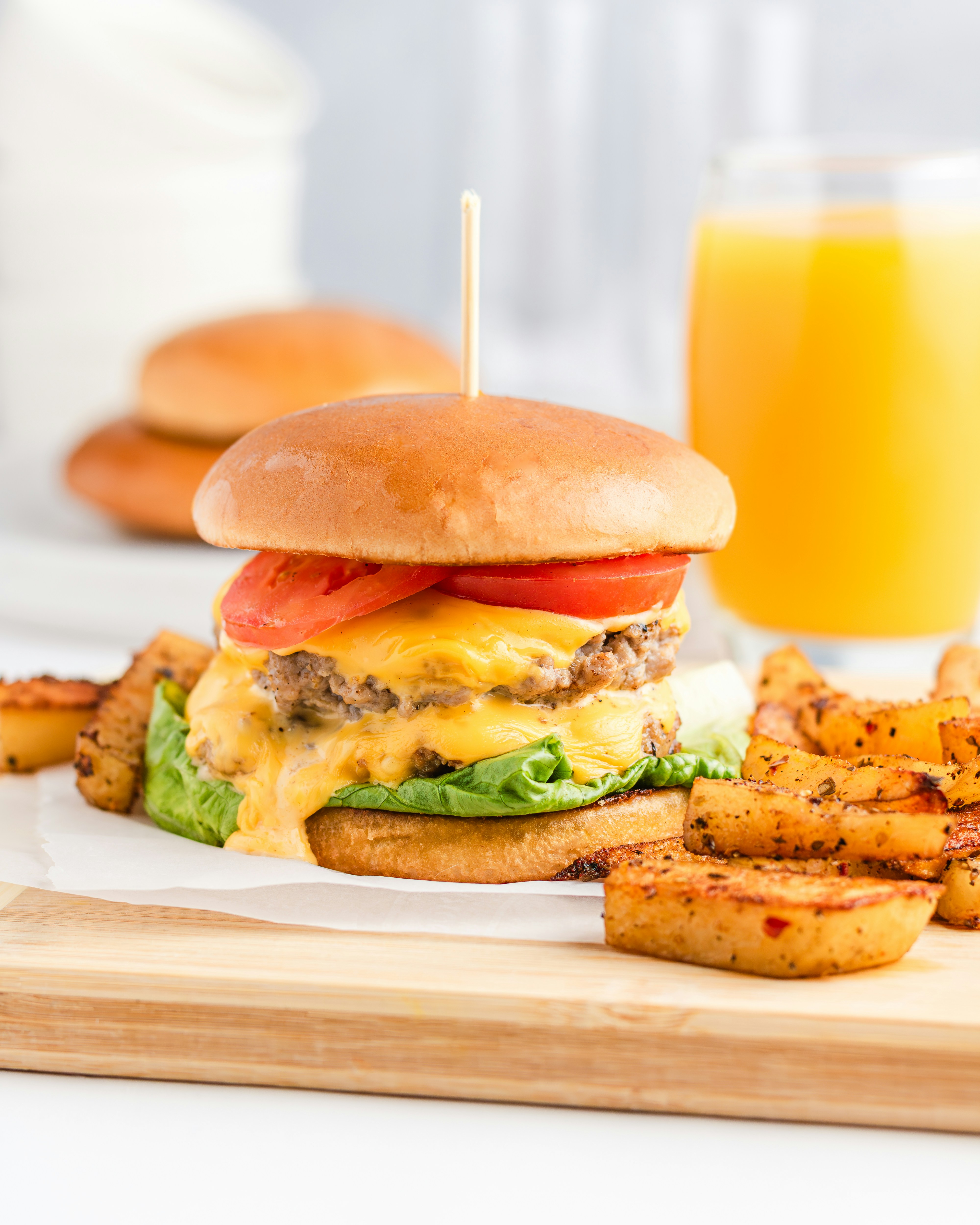 A cheeseburger with fries and a glass of orange juice photo – Free ...
