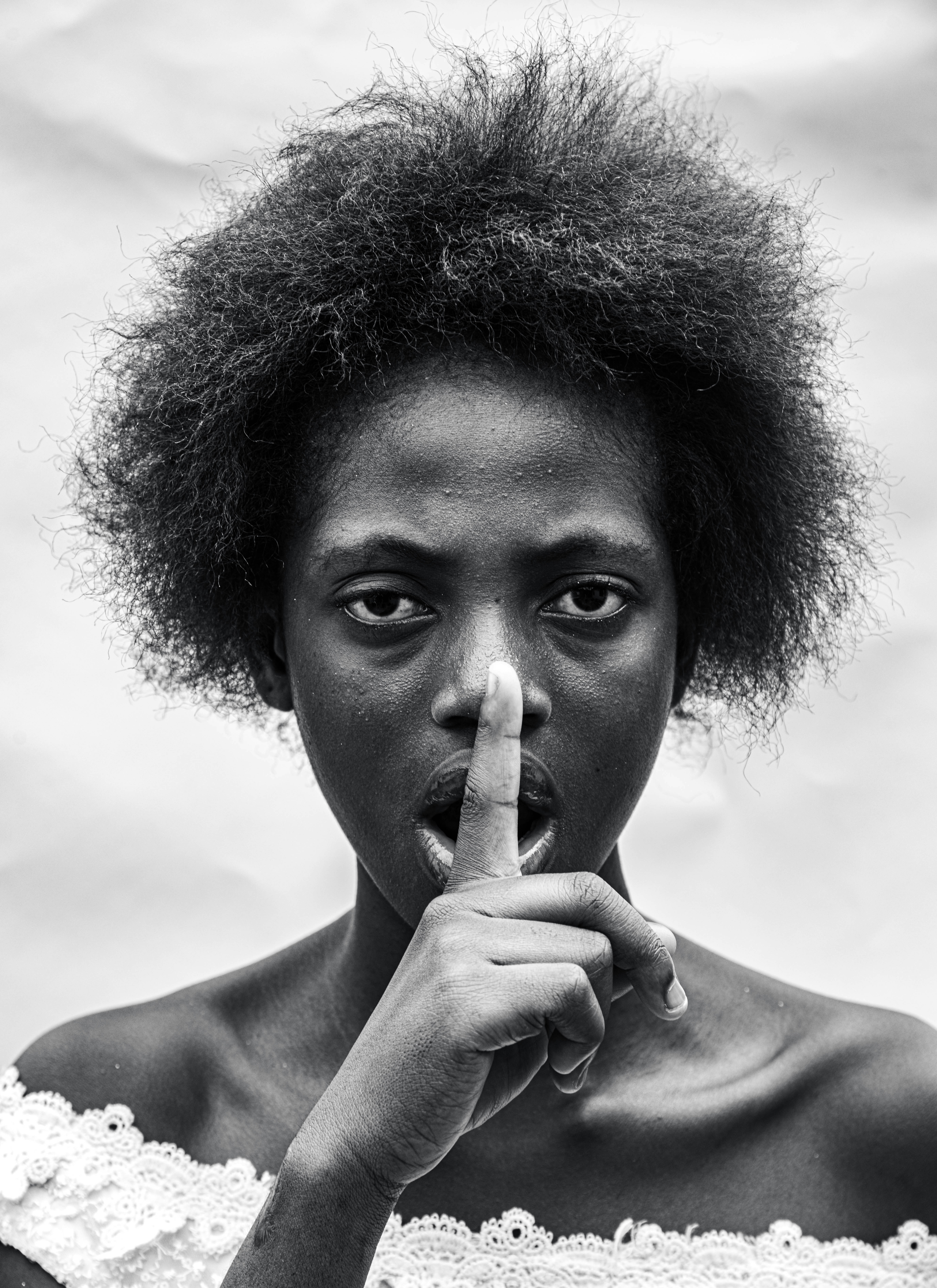 A black and white photo of a woman making a finger sign photo – Free ...