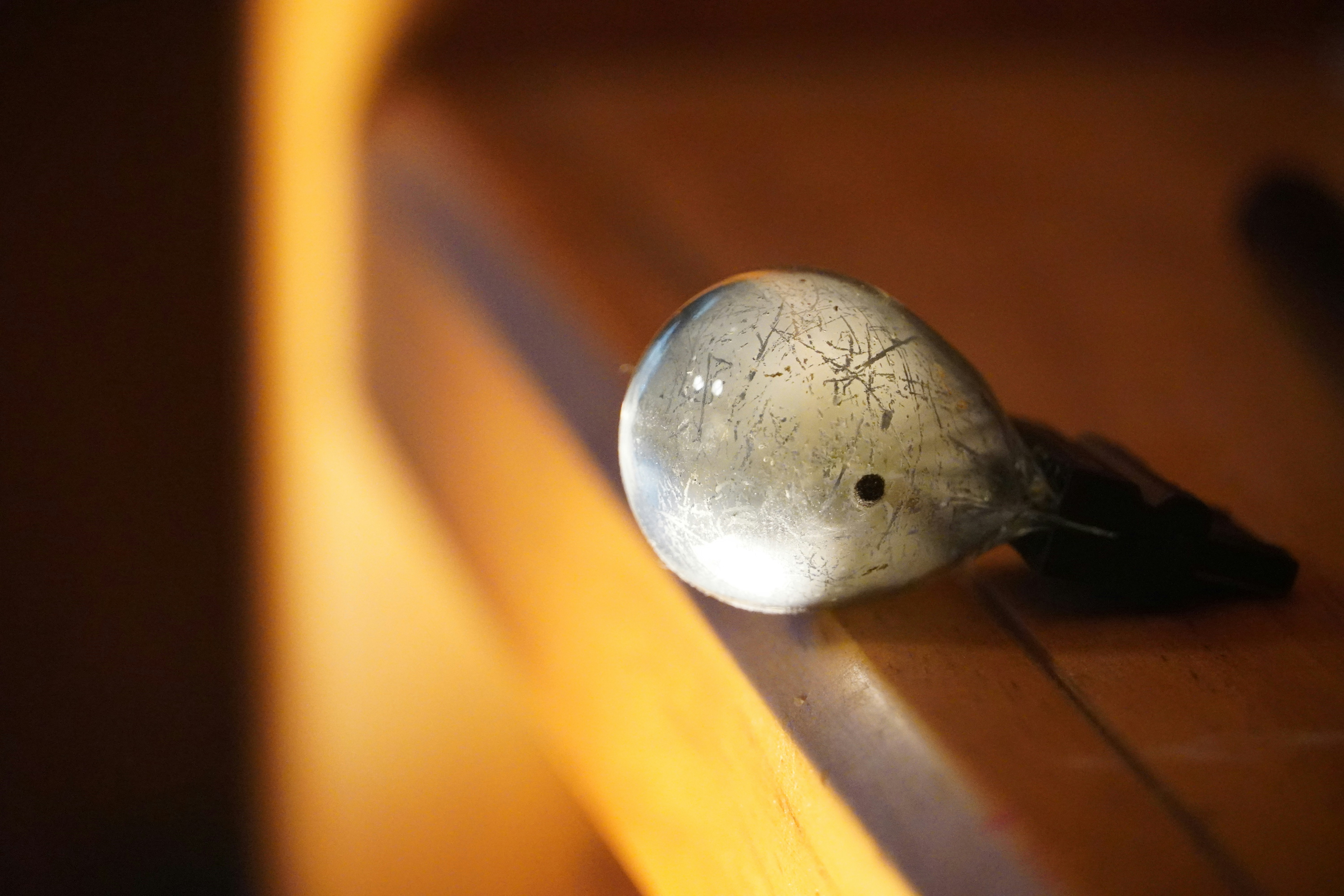 Amber-Glowed Marble: Crackled Glass on a Sunlit Wood Edge
