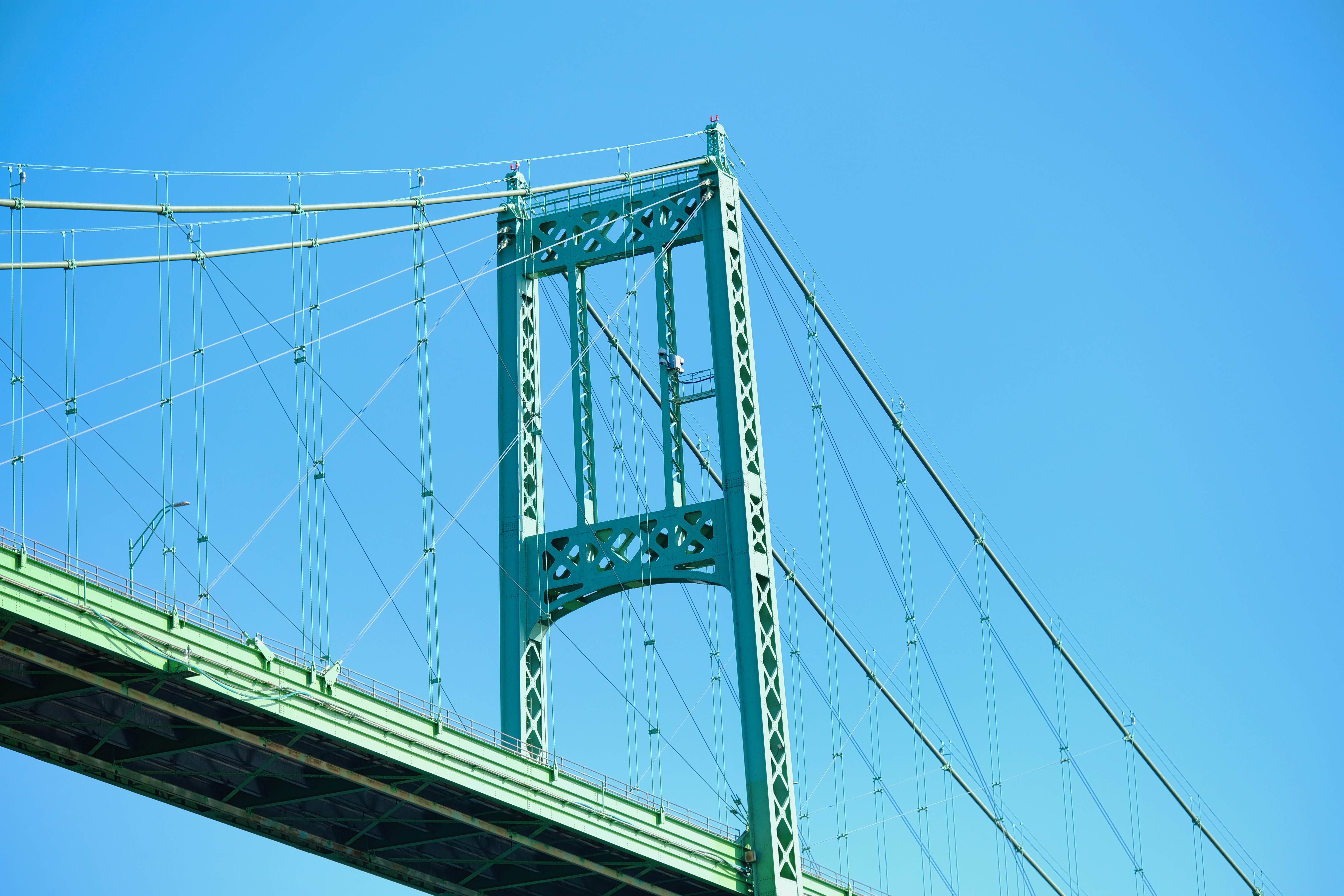 A view of a bridge with a blue sky in the background photo – Free ...