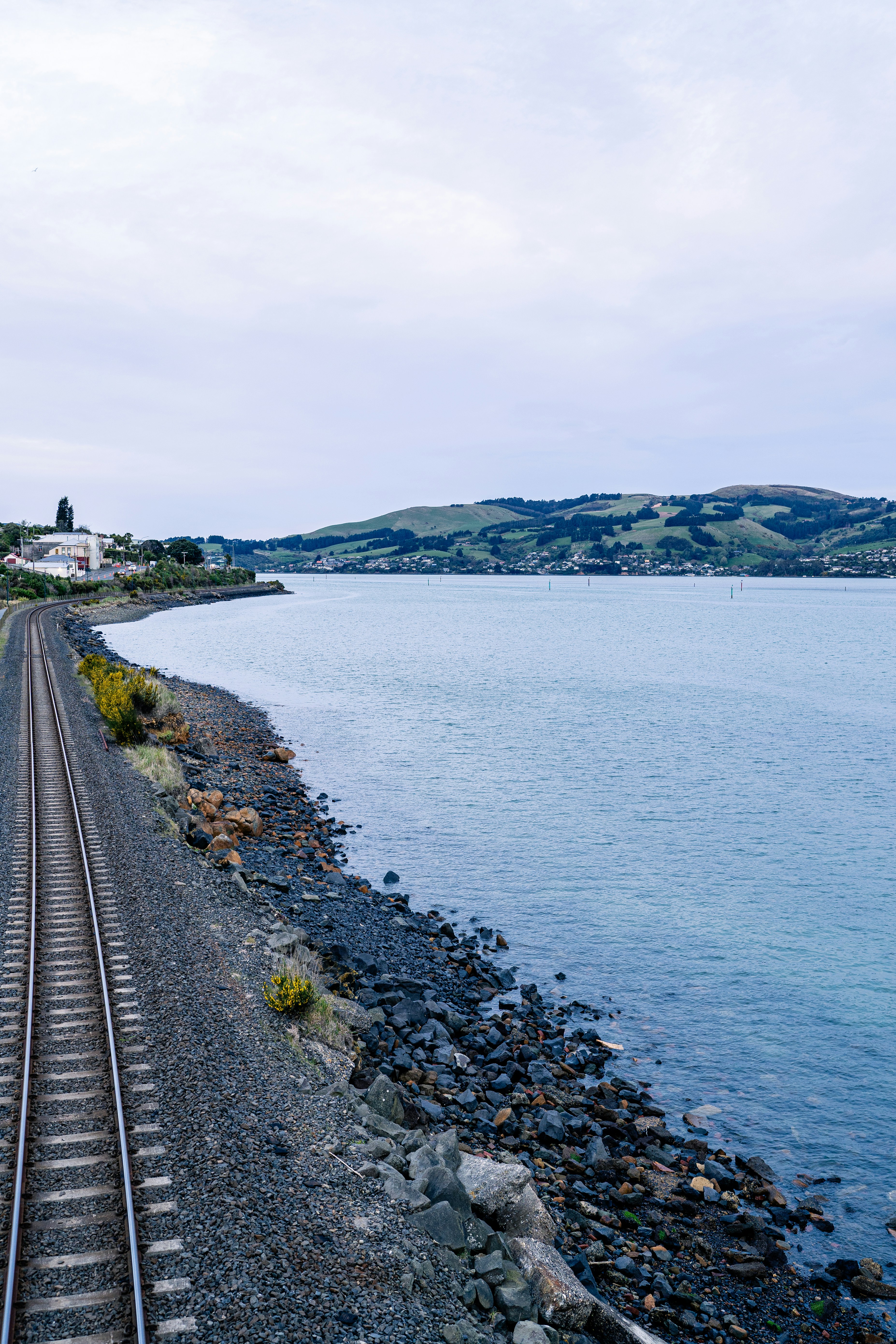 A train track next to a body of water photo – Free Scenery Image on ...
