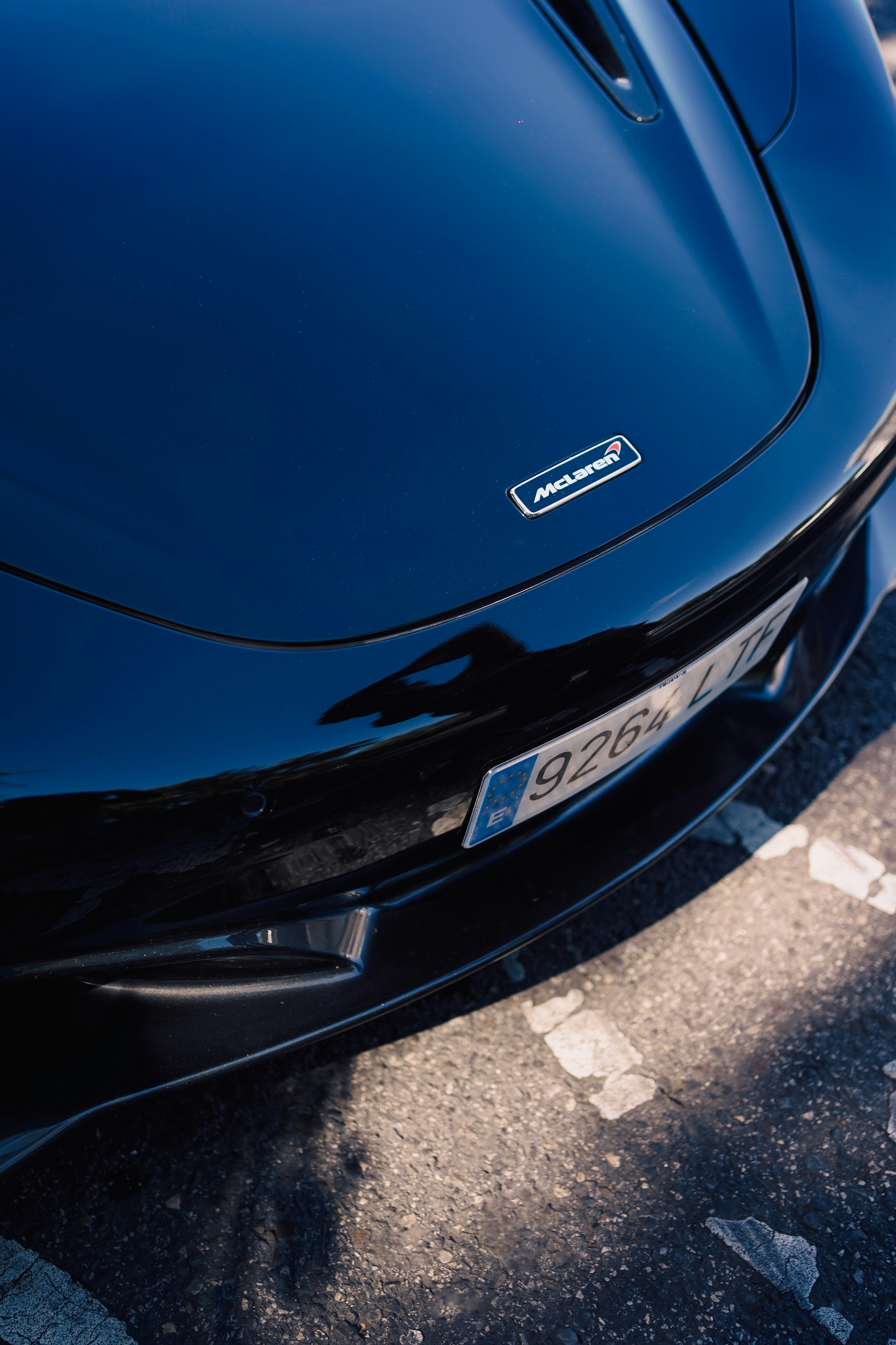 Blue Velocity: The McLaren badge glinting along the sculpted rear hood