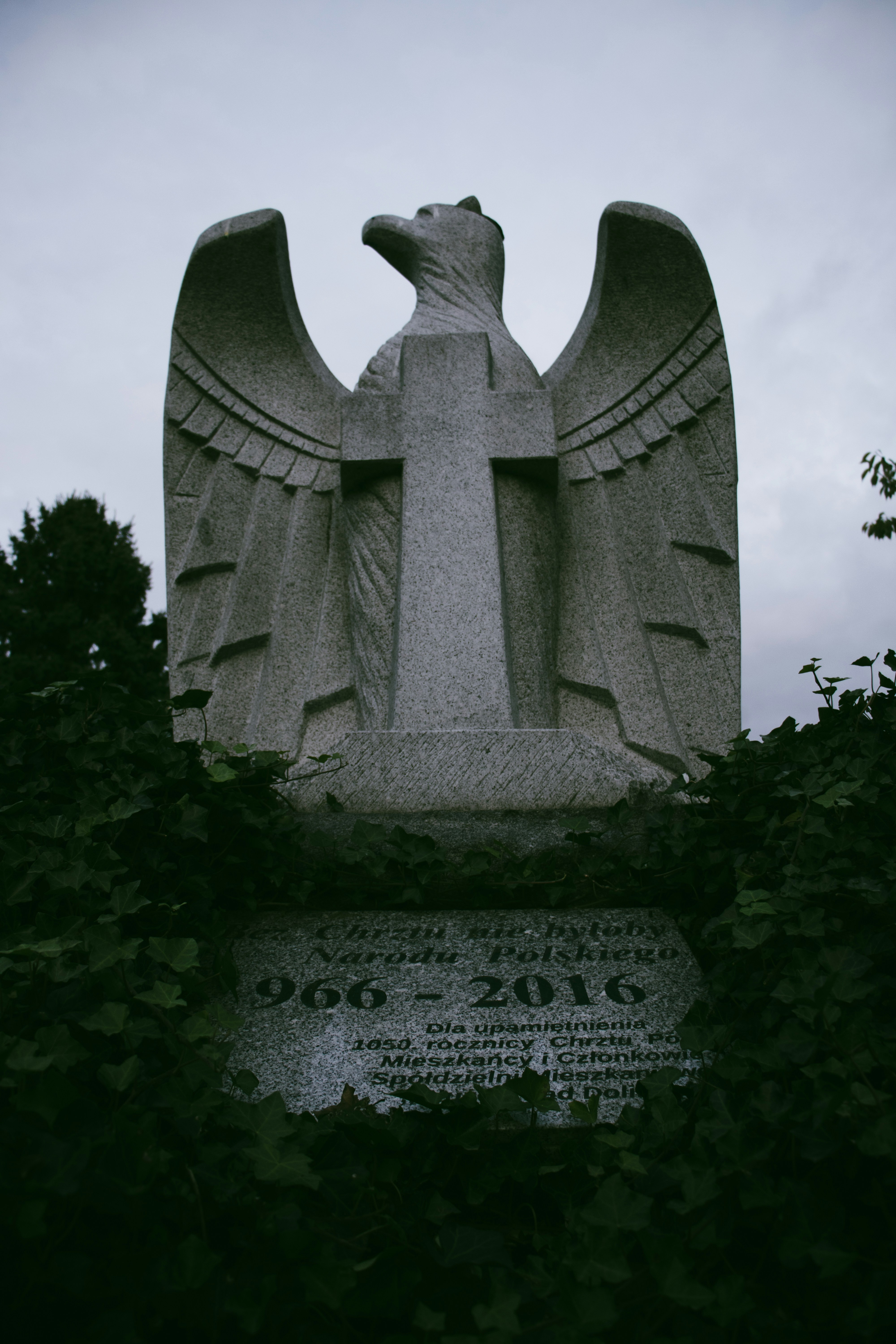 Winged Sentinel Over a Weathered Memorial