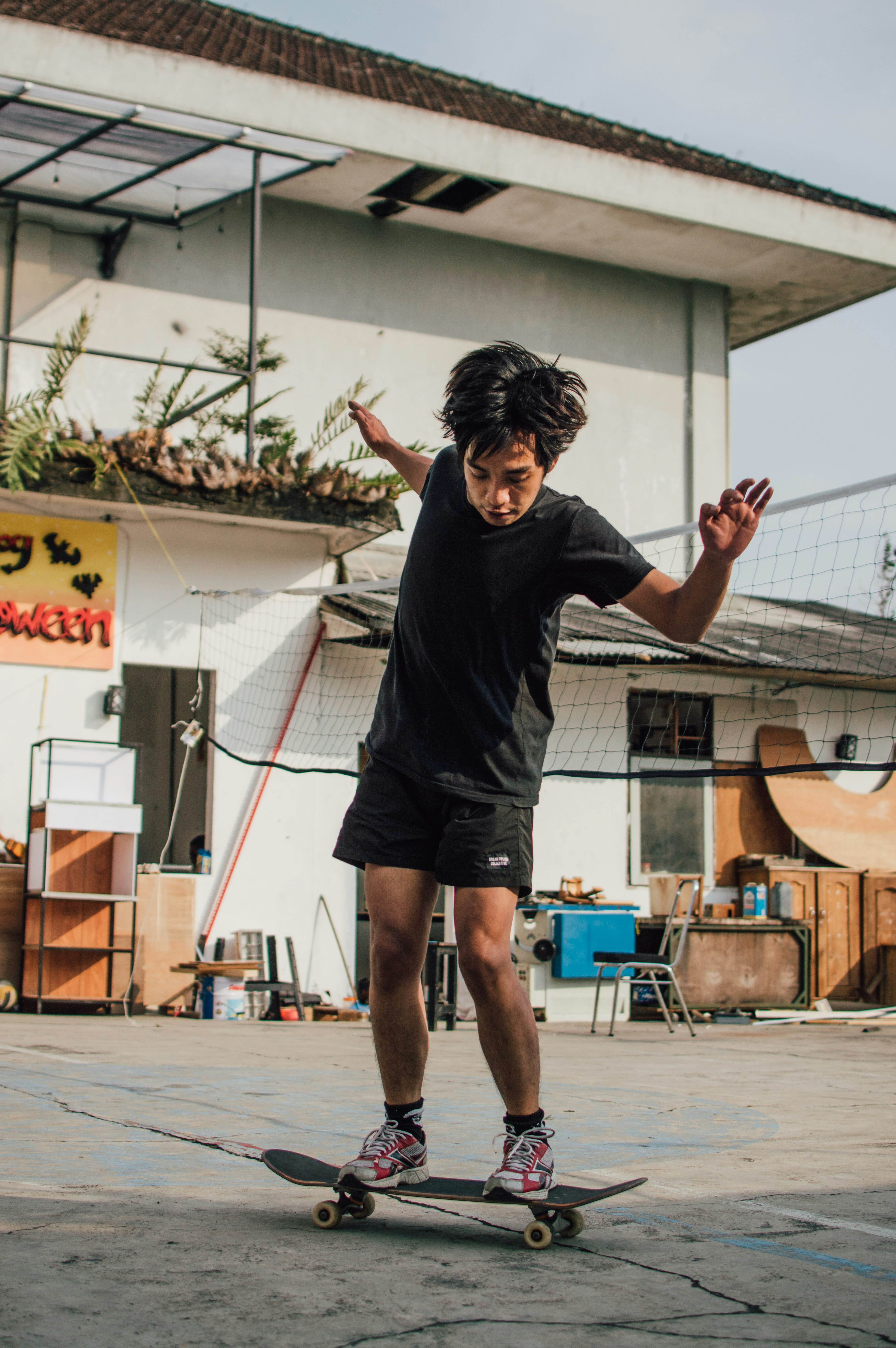 Centered Ride: A skater mid-trick beneath a sunlit courtyard roof