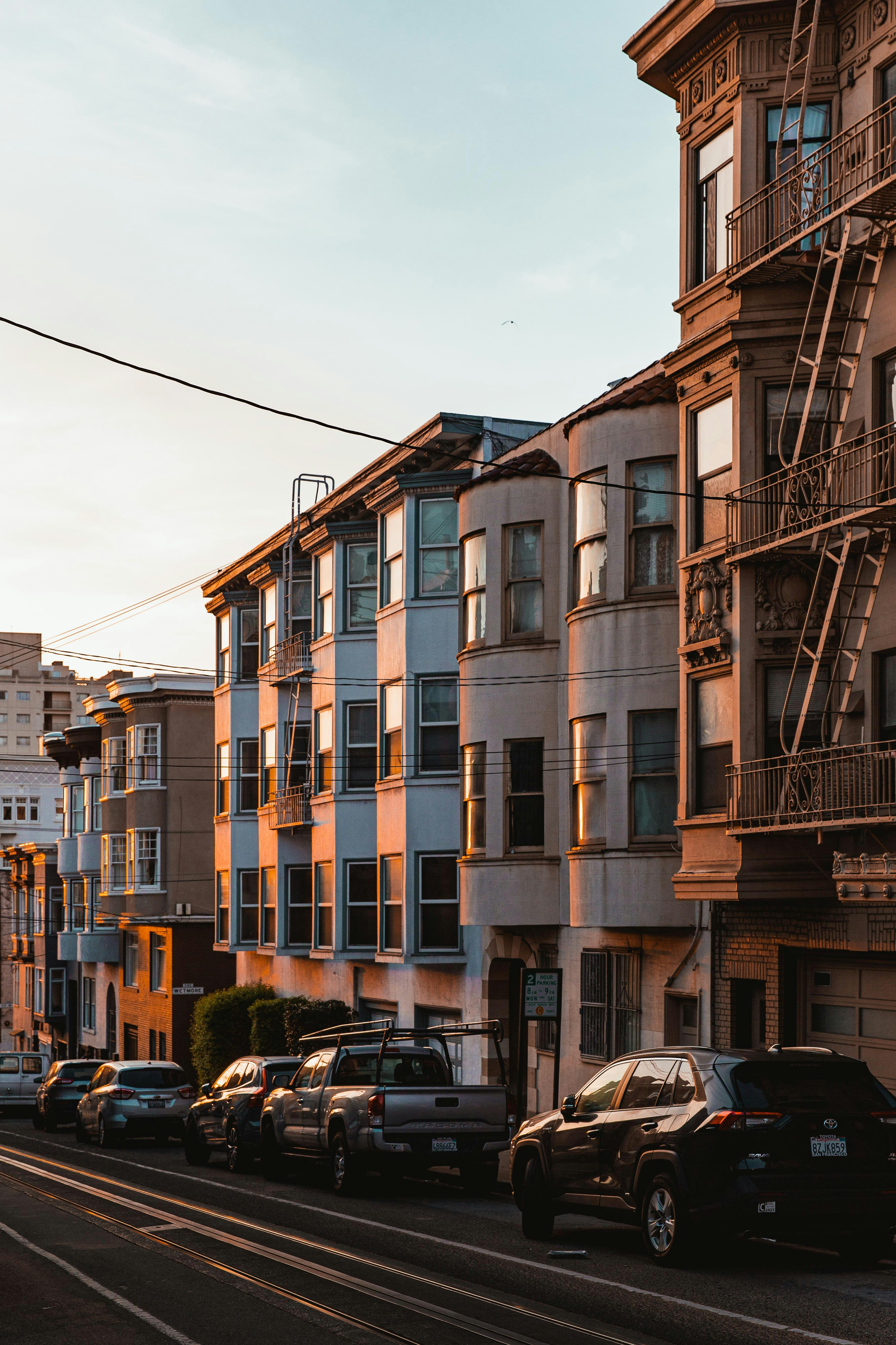 A row of apartment buildings on a city street photo – Free San ...