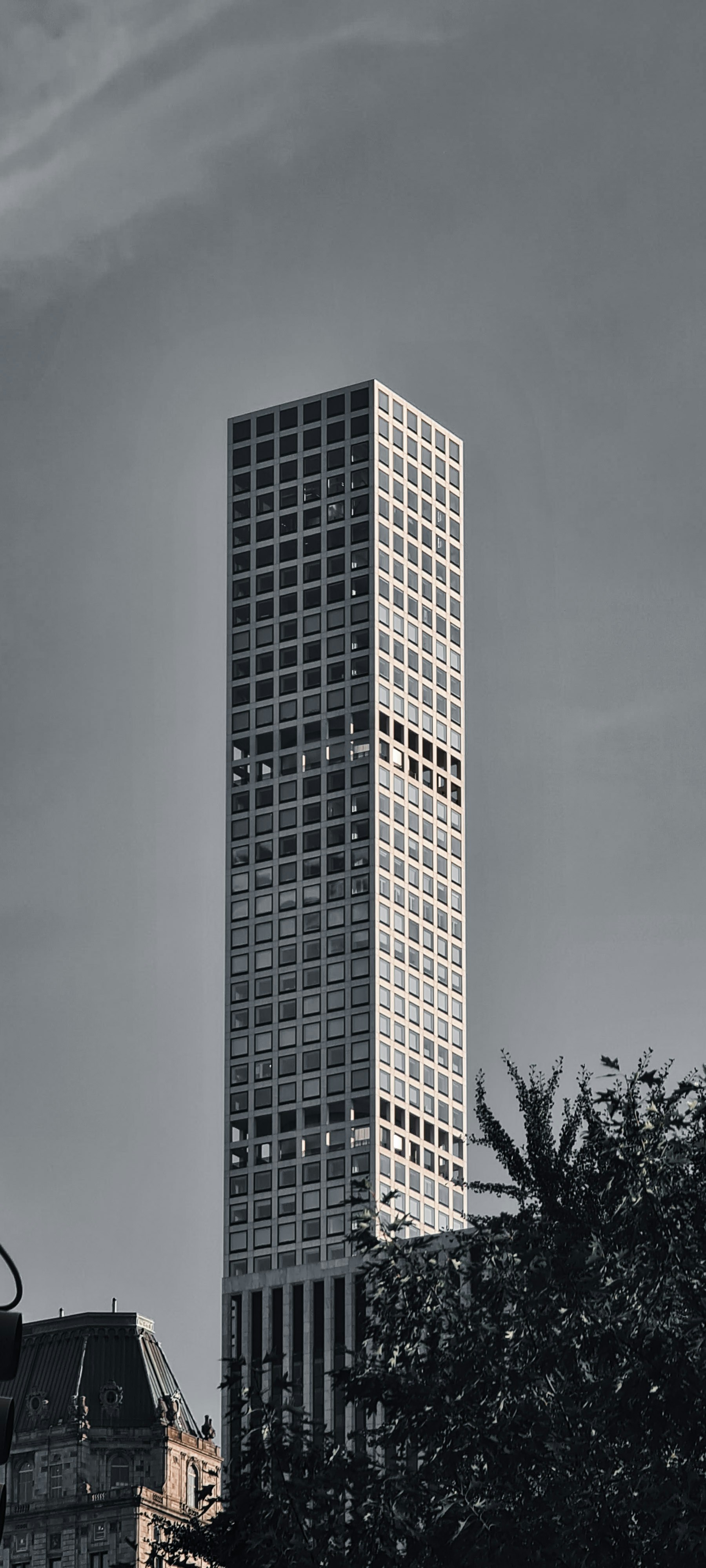 A very tall building towering over a city photo – Free Grey Image on ...