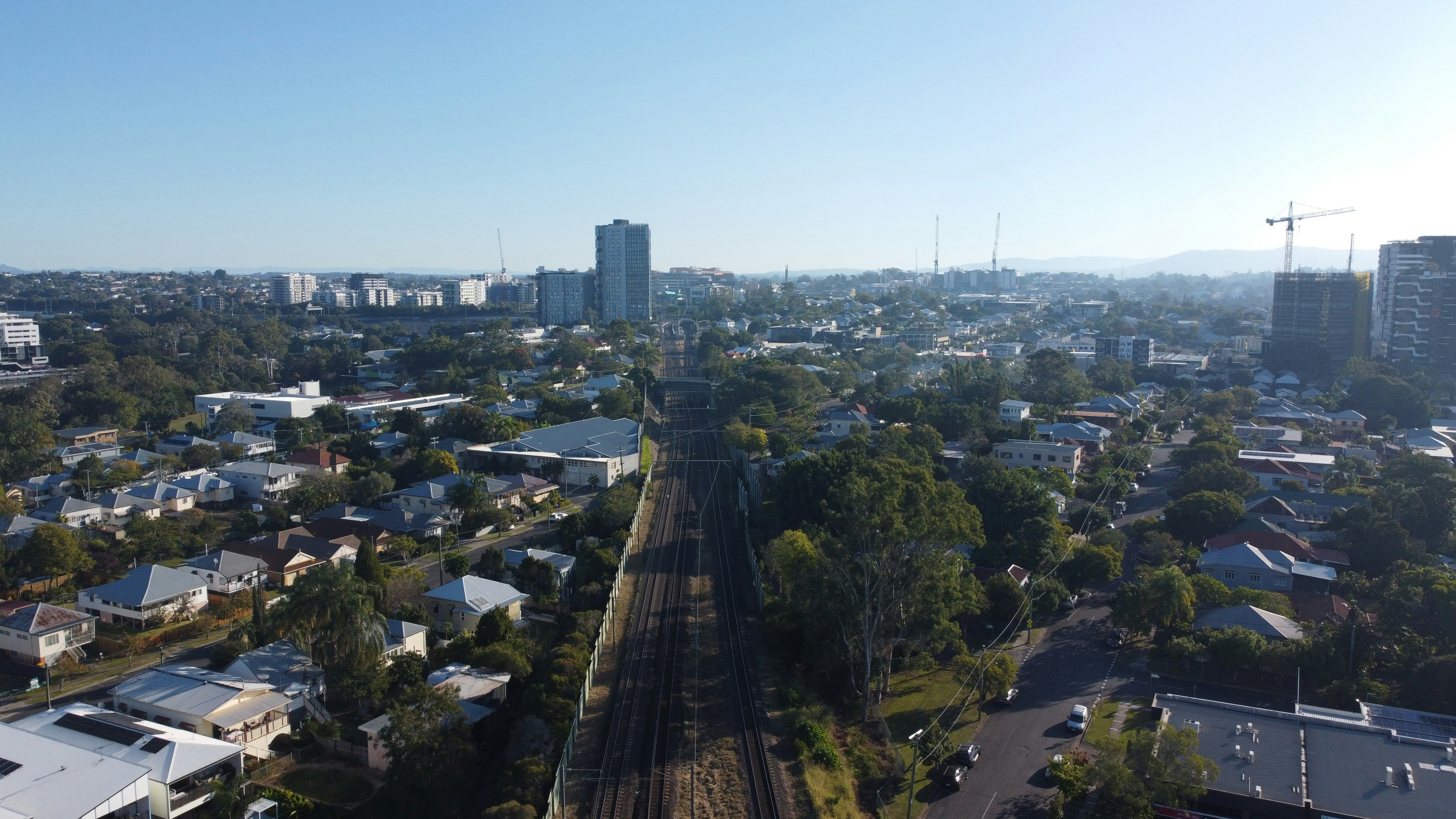 An aerial view of a city with a train on the tracks photo – Free ...