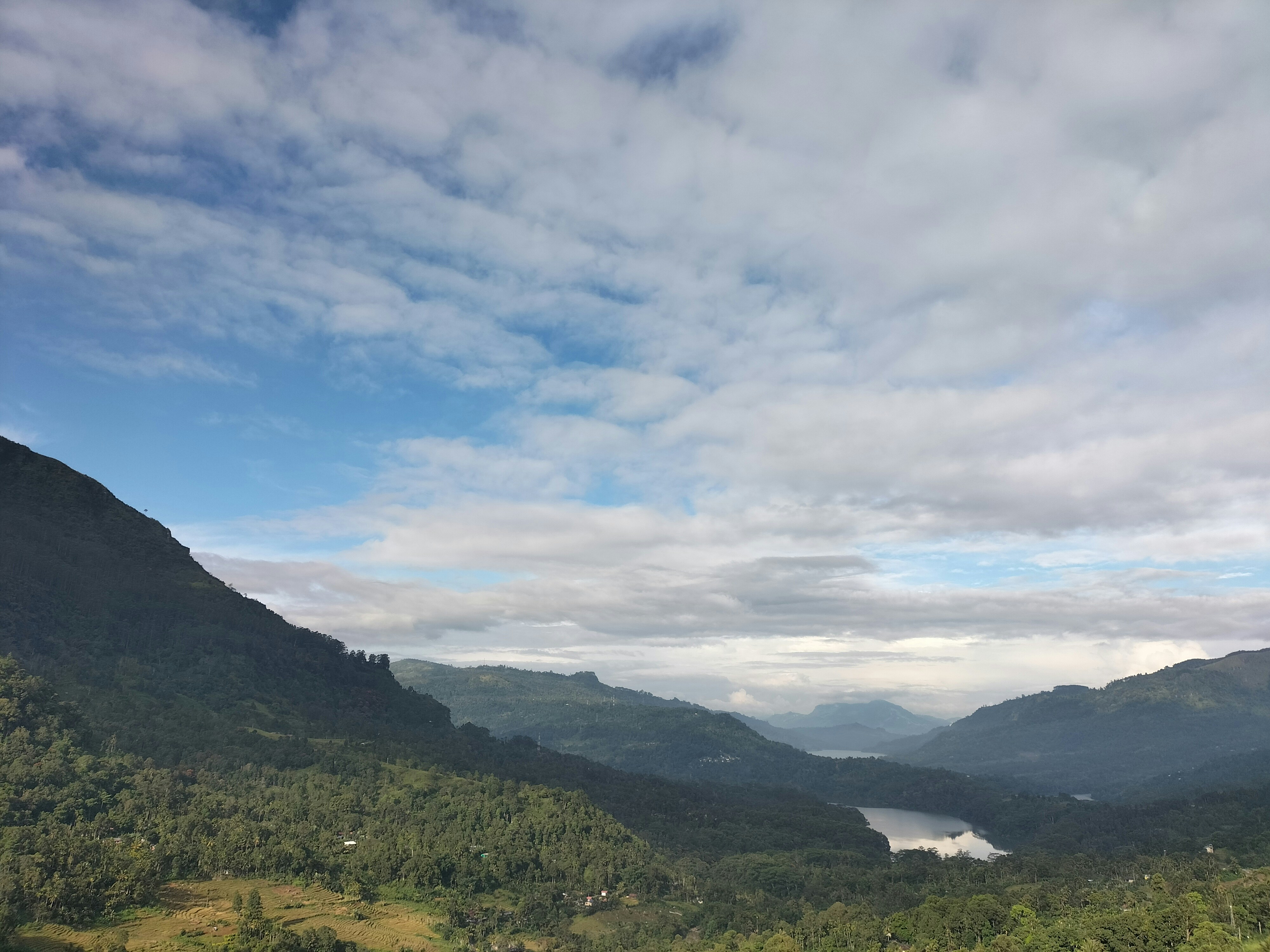 a scenic view of a lake surrounded by mountains
