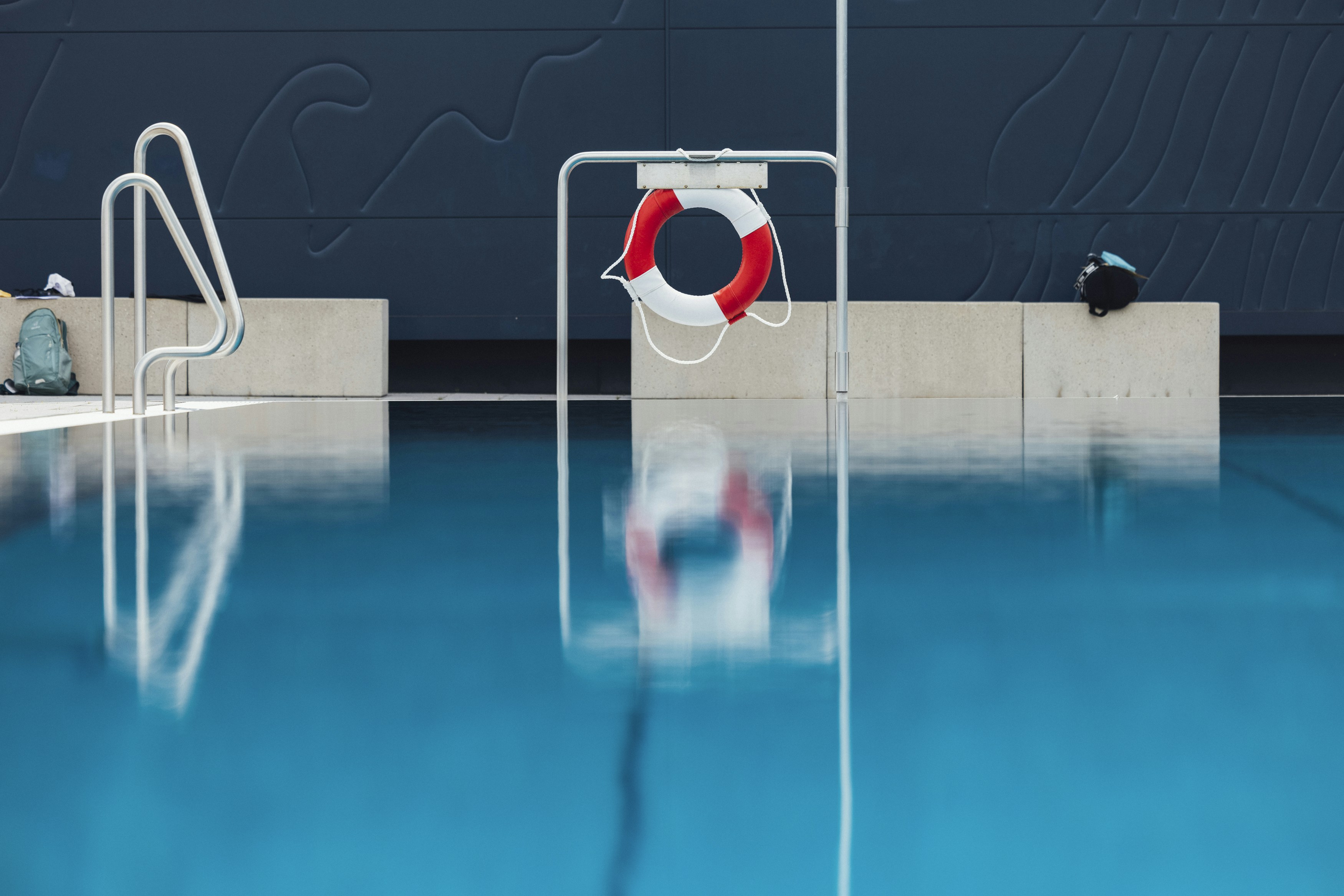 A swimming pool with a life preserver next to it photo – Free Pool ...