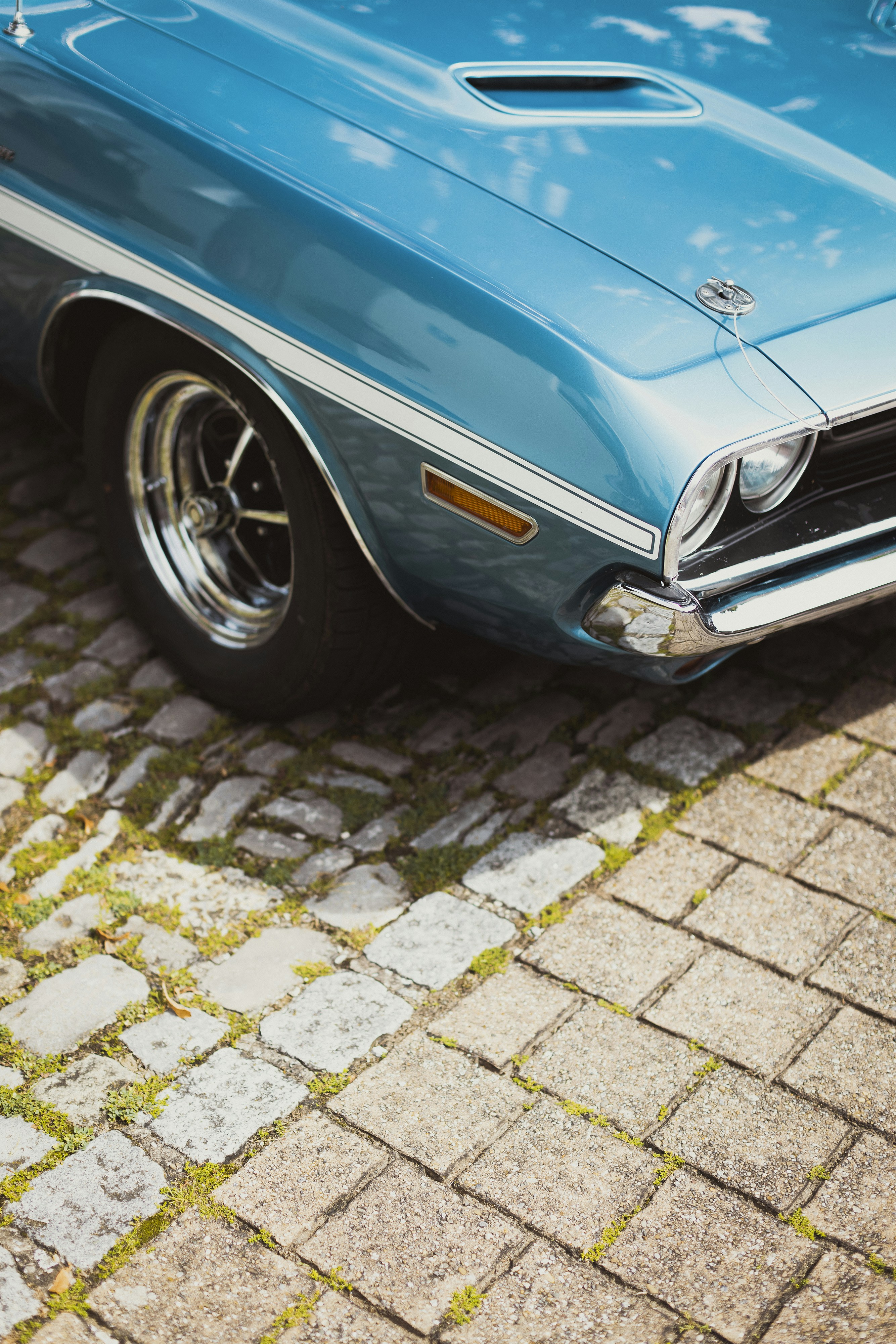 A blue muscle car parked on a cobblestone street photo – Free Headlight ...