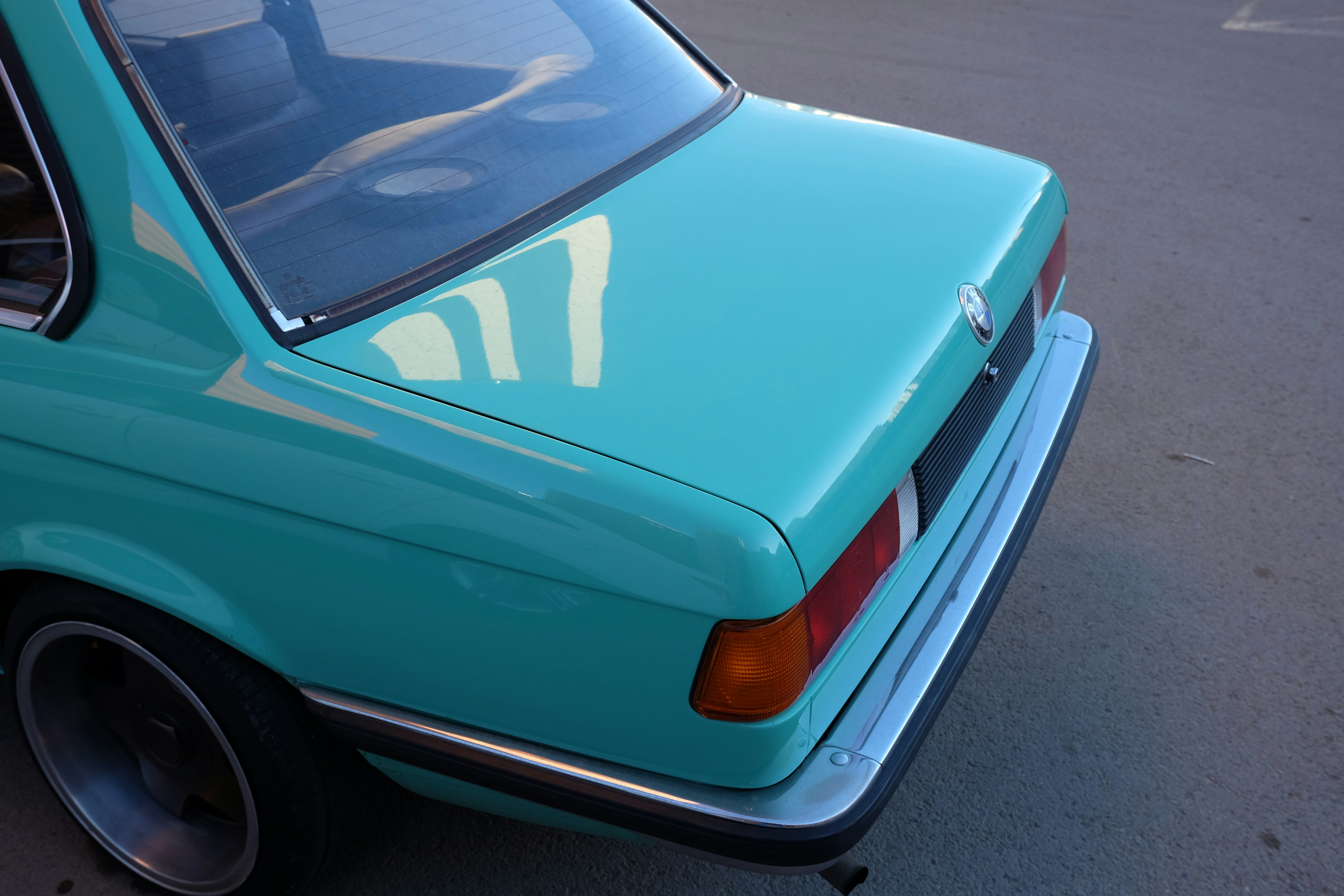 Teal Classic: Chrome Bumper and Tail Light in Quiet Daylight