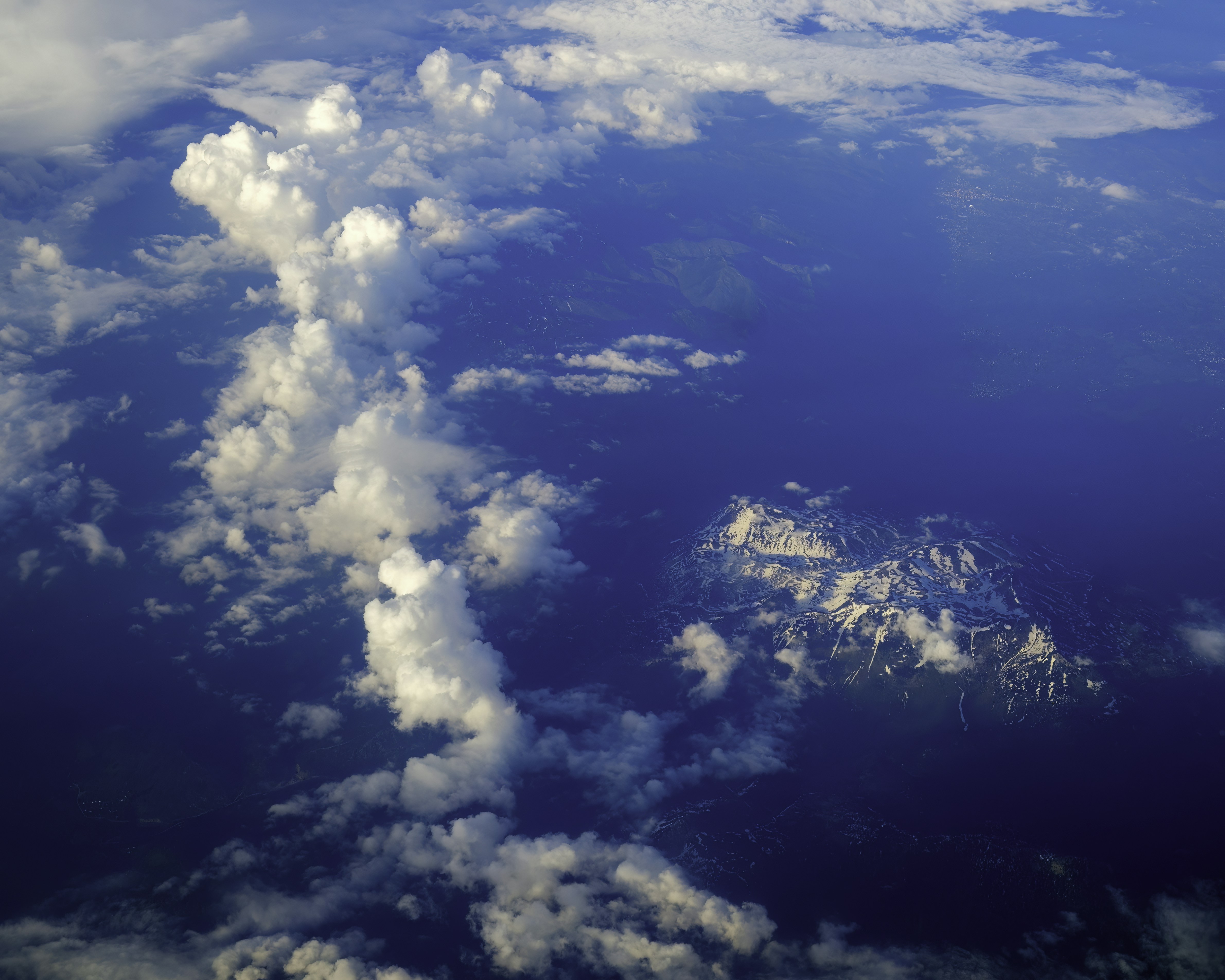 An aerial view of clouds and land from a plane photo – Free Alps Image ...